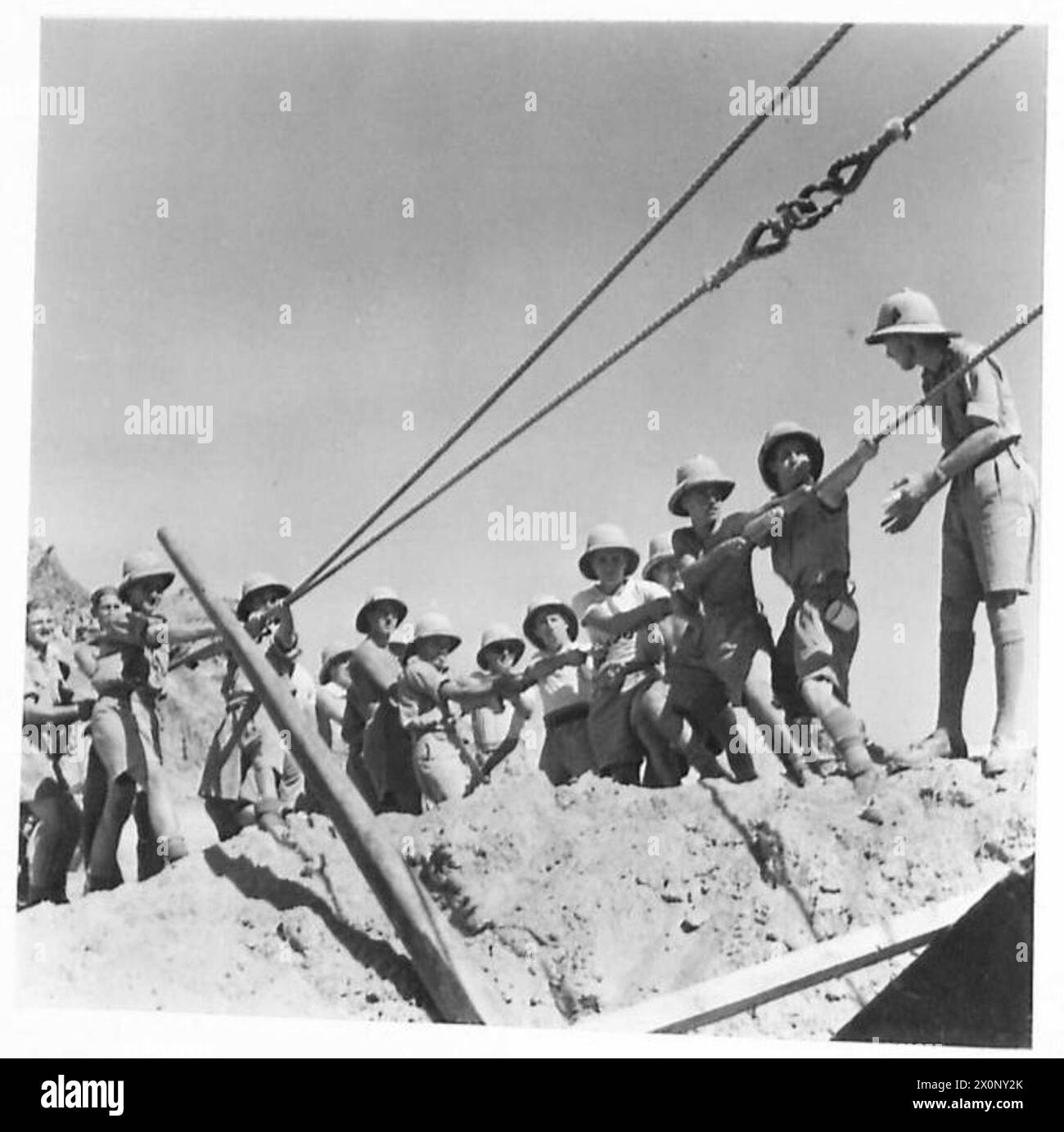 WITH THE GUNNERS IN CYPRUS - Men hauling the ropes to place the gun ...