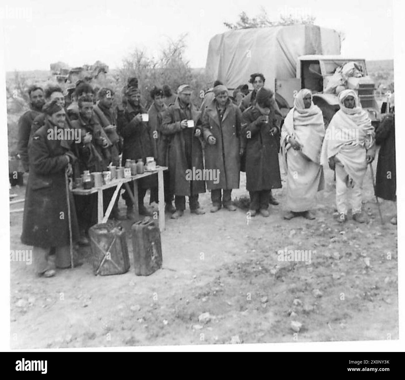 STRAGGLERS FROM BENGHAZI REACH OUR LINES - Some of the 21 men eating ...