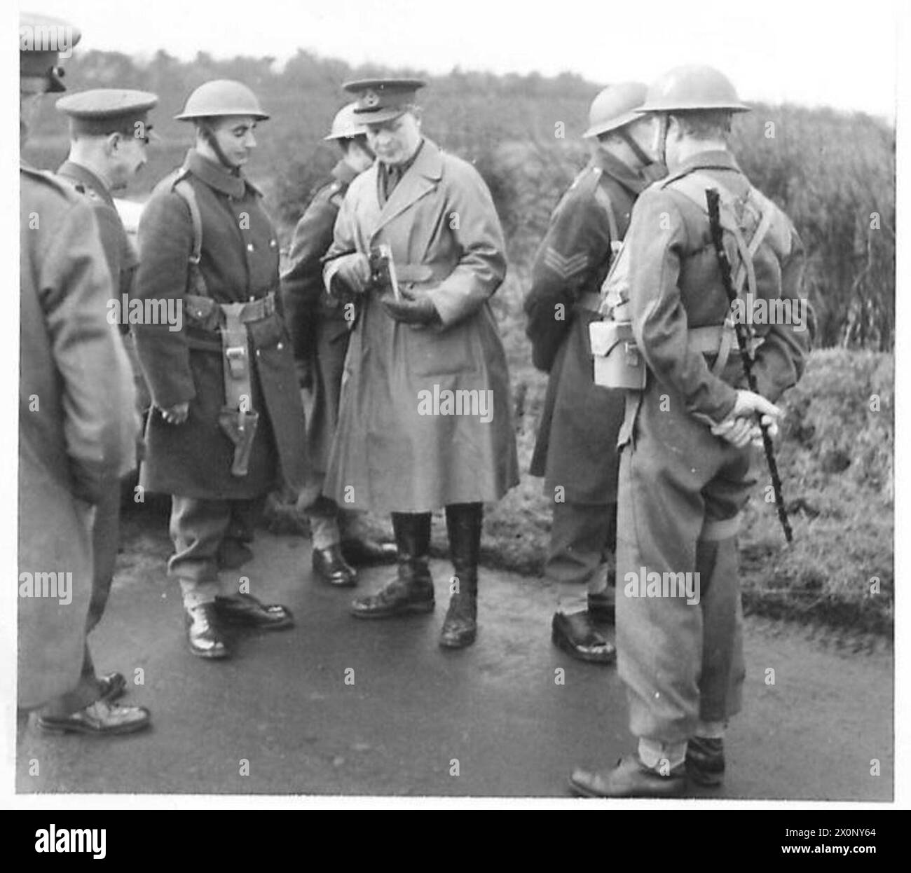 Lord Gort inspects a soldier’s revolver, demonstrating the focus on ...