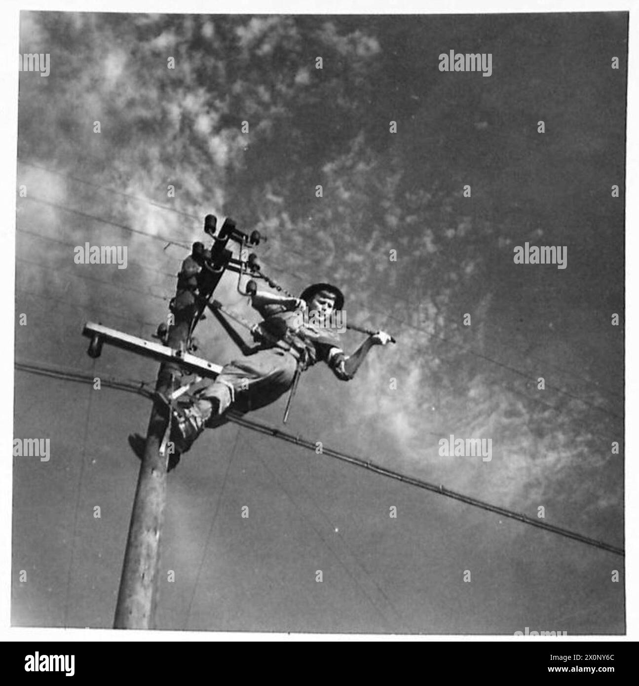 ROYAL CORPS OF SIGNALS - A line man jointing wire on permanent line ...