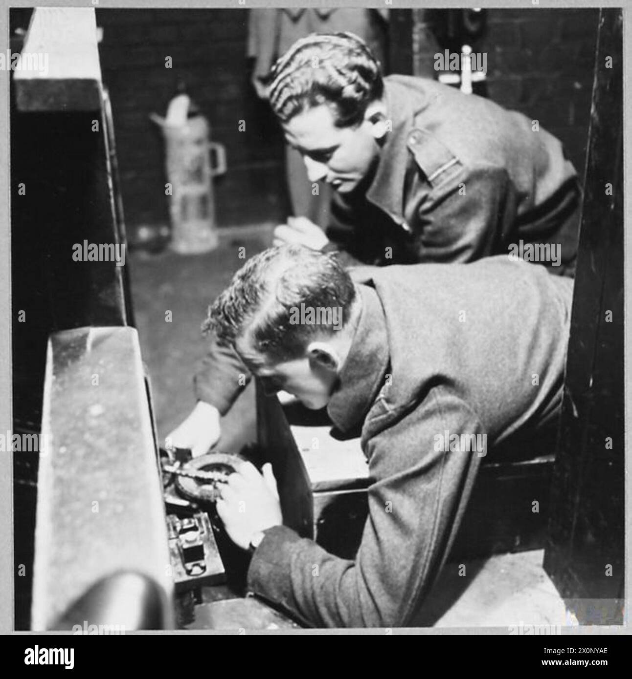 RAF bomber pilots in training practice using a bomb sight in a darkened ...