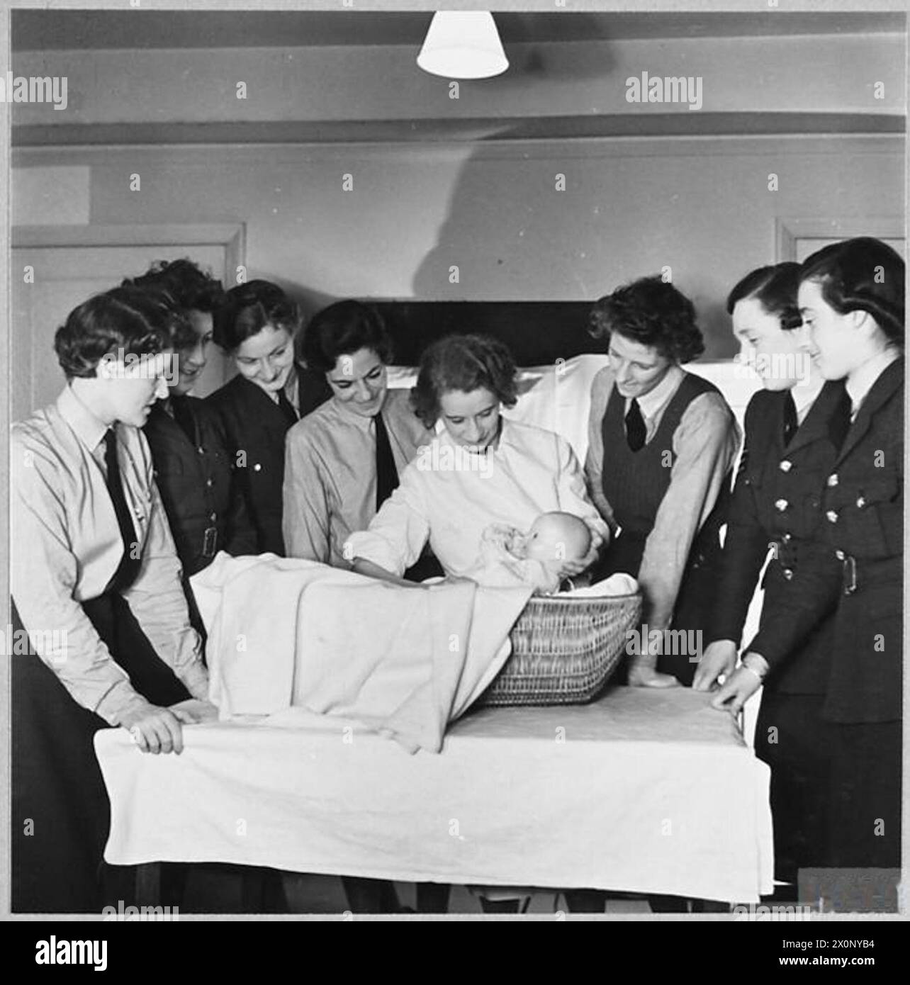 Women of the WAAF stationed at an RAF unit in London are shown ...