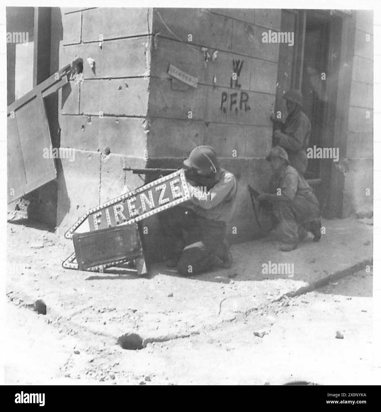 Photographic negative showing a French soldier taking cover behind a ...
