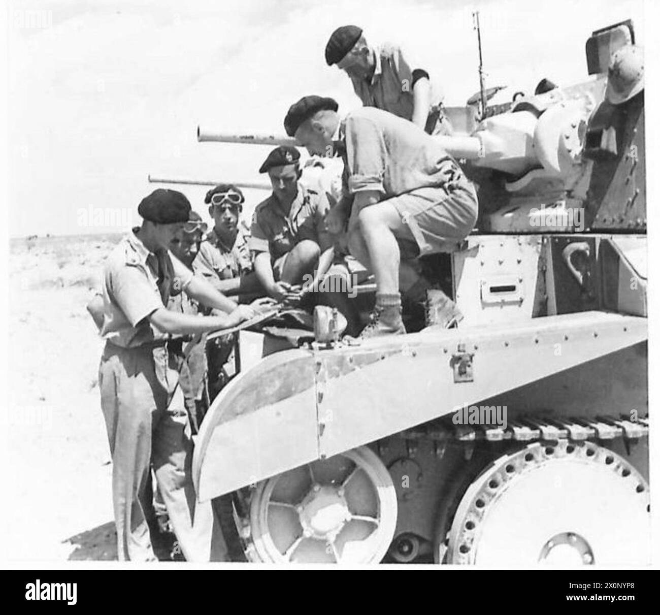 WITH THE TANKS IN THE WESTERN DESERT - A tank commander giving ...