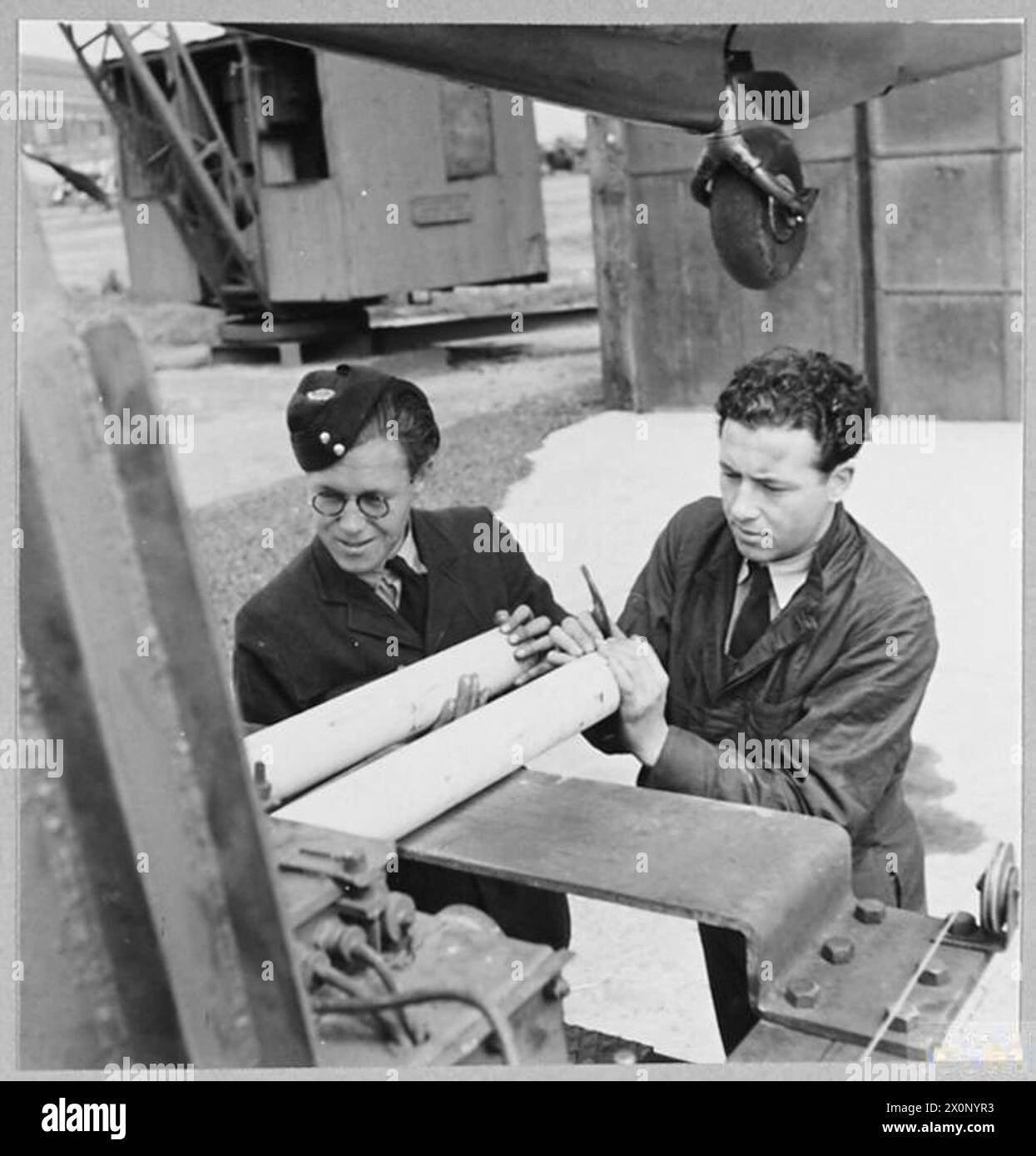 Personnel are shown installing firing rockets on a Merchant Service ...