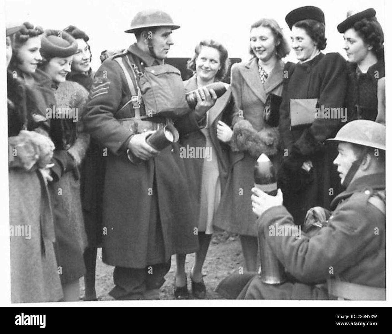 MUNITIONS WORKERS VISIT ARMY UNITS - A sergeant of the Royal Artillery ...
