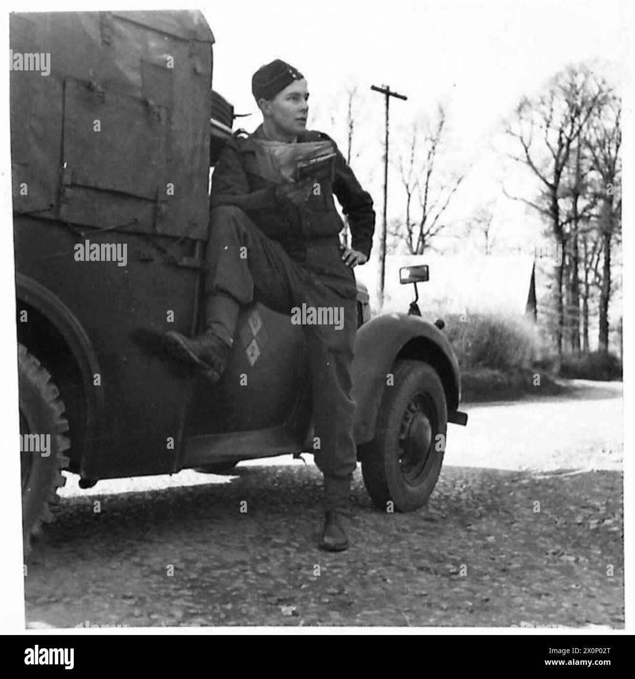 SIGNALLERS AT WORK IN THE FIELD - A Signals officer standing beside an ...