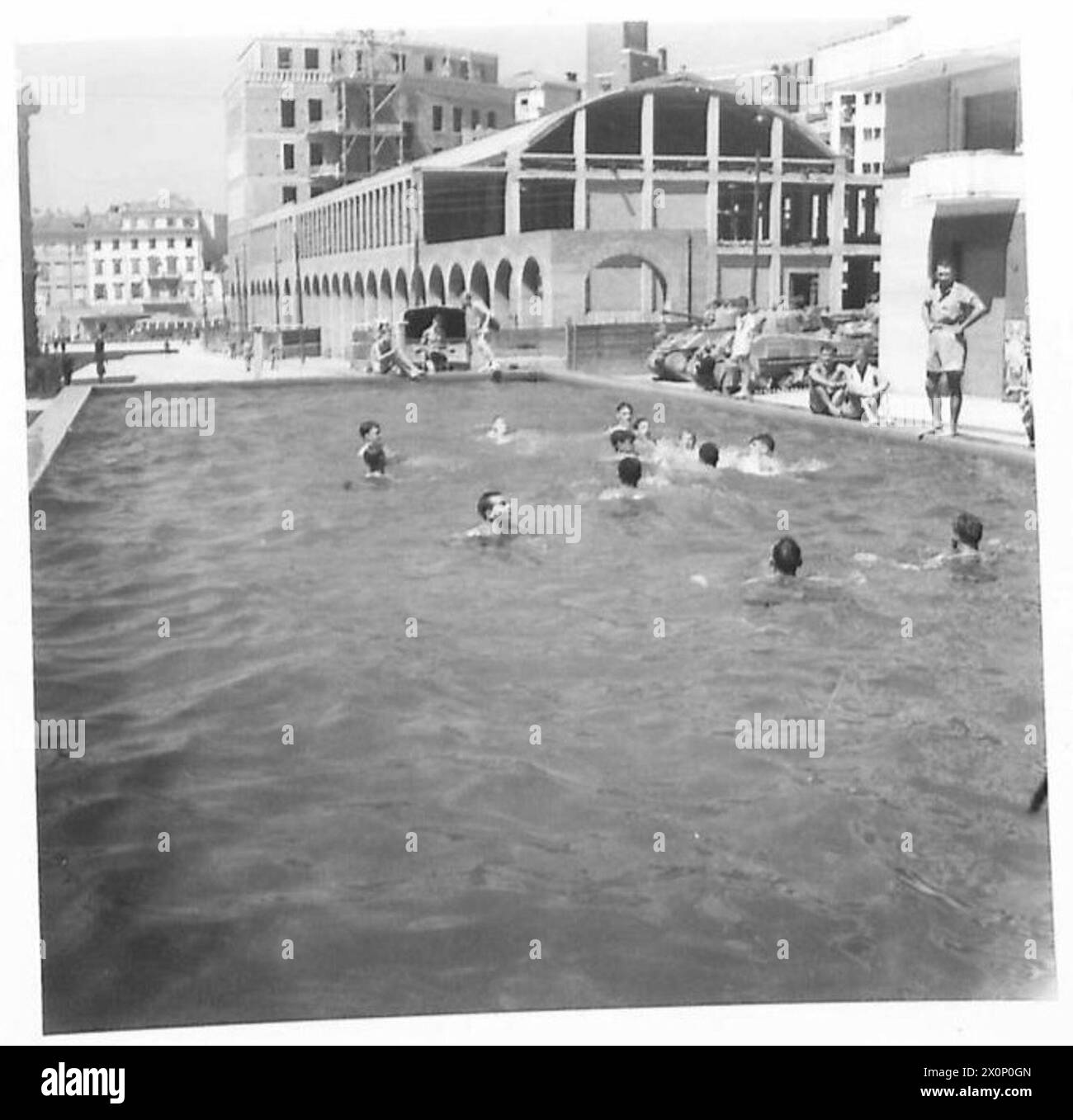 Tank crews from the New Zealand Armoured Regiment enjoy a swim in a ...