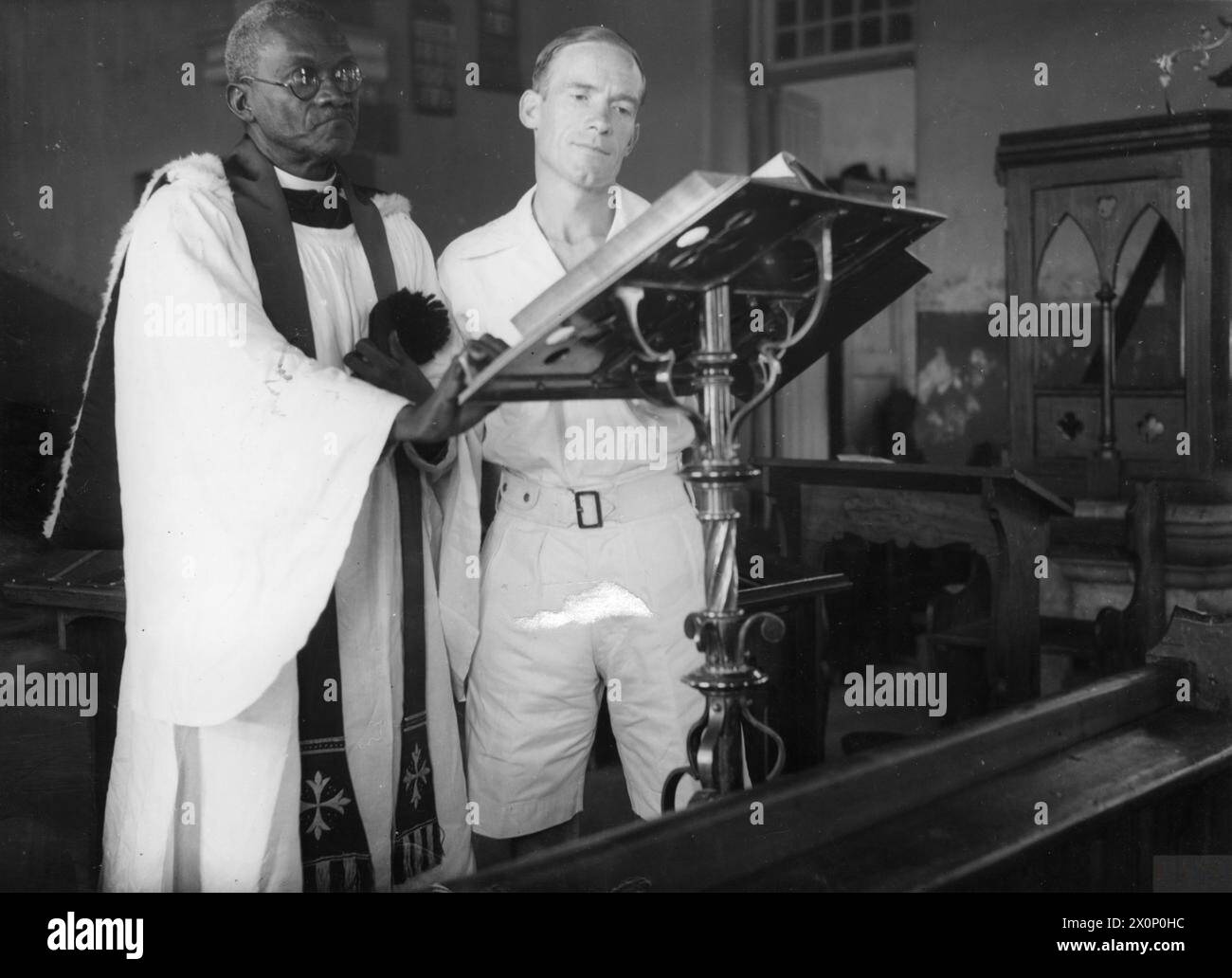 Petty Officer Palenthorpe assists Rev. Elliot Spain in preparing church ...