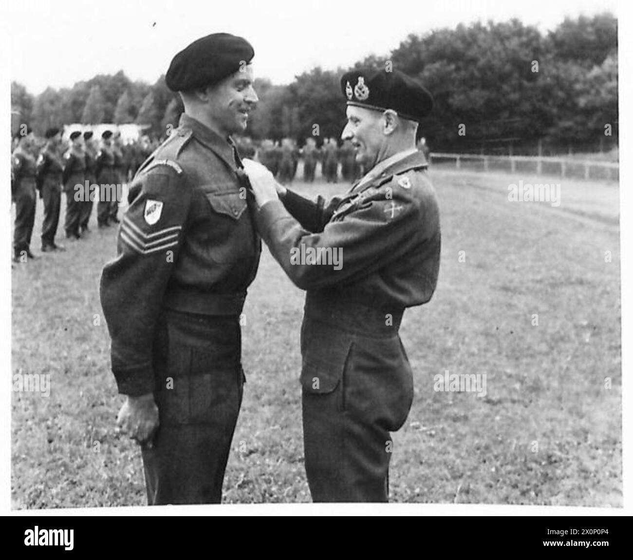 Sergeant G.H. Brooker of 4th Tank Coldstream Guards receives the ...