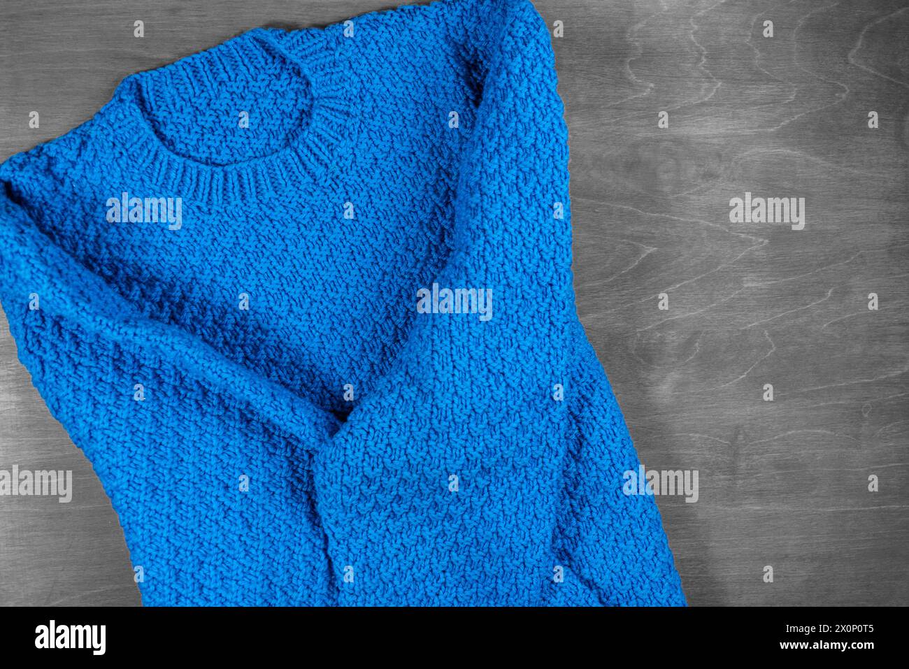 Warm winter handmade knitted blue wool sweater Stock Photo - Alamy