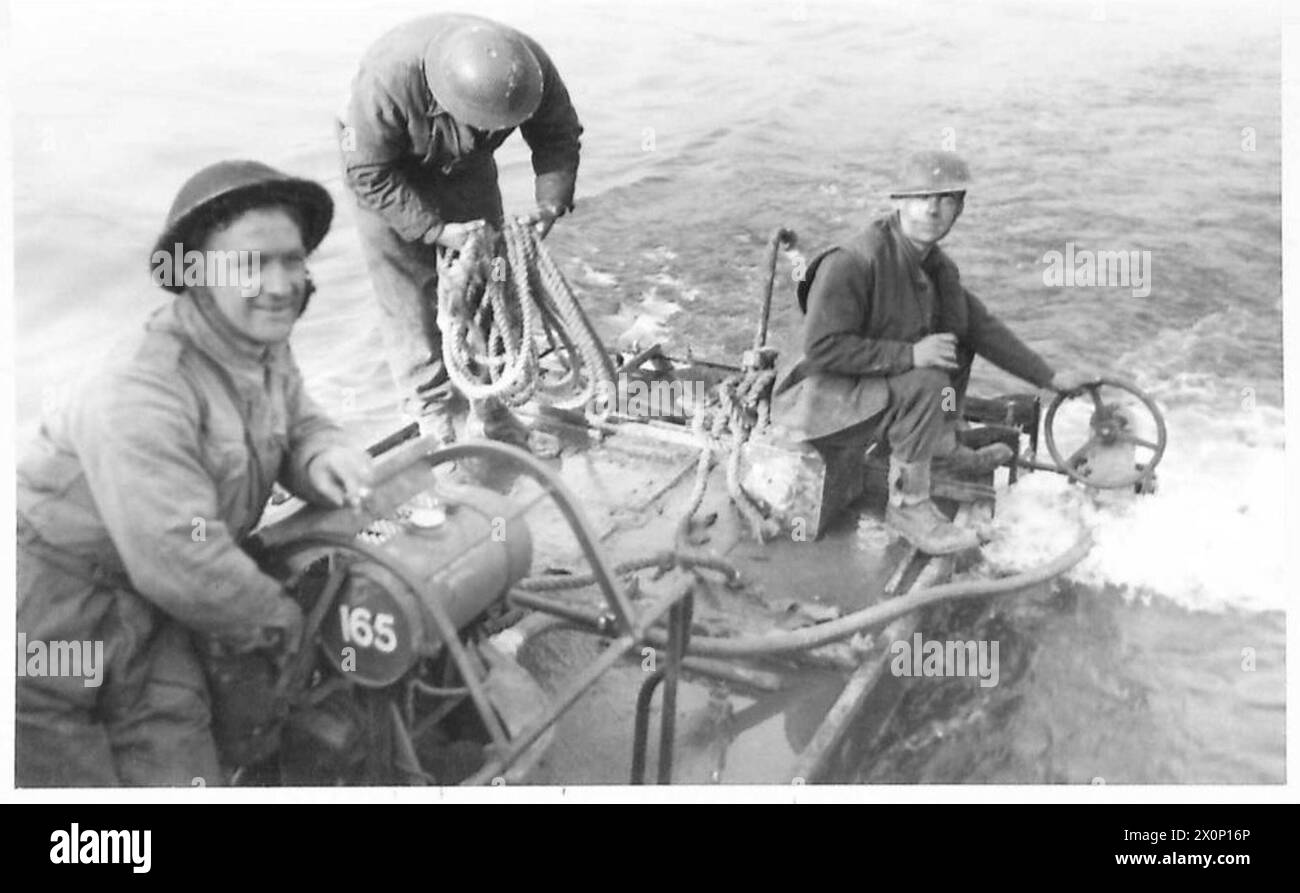 12TH CORPS CROSS THE RHINE - R.E.Sappers tending the outboard motors ...