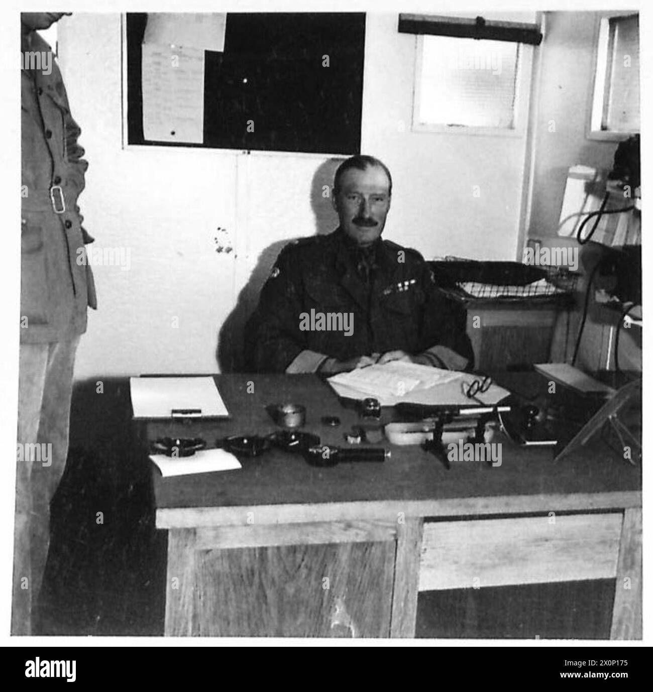 A CORPS HQ. IN FRANCE - Gen. Ritchie at his desk in his office in a ...
