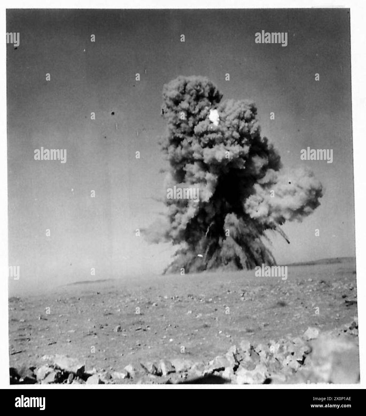 MAKING TANK PITS - A huge explosion as one of the 500 lb. enemy bombs ...