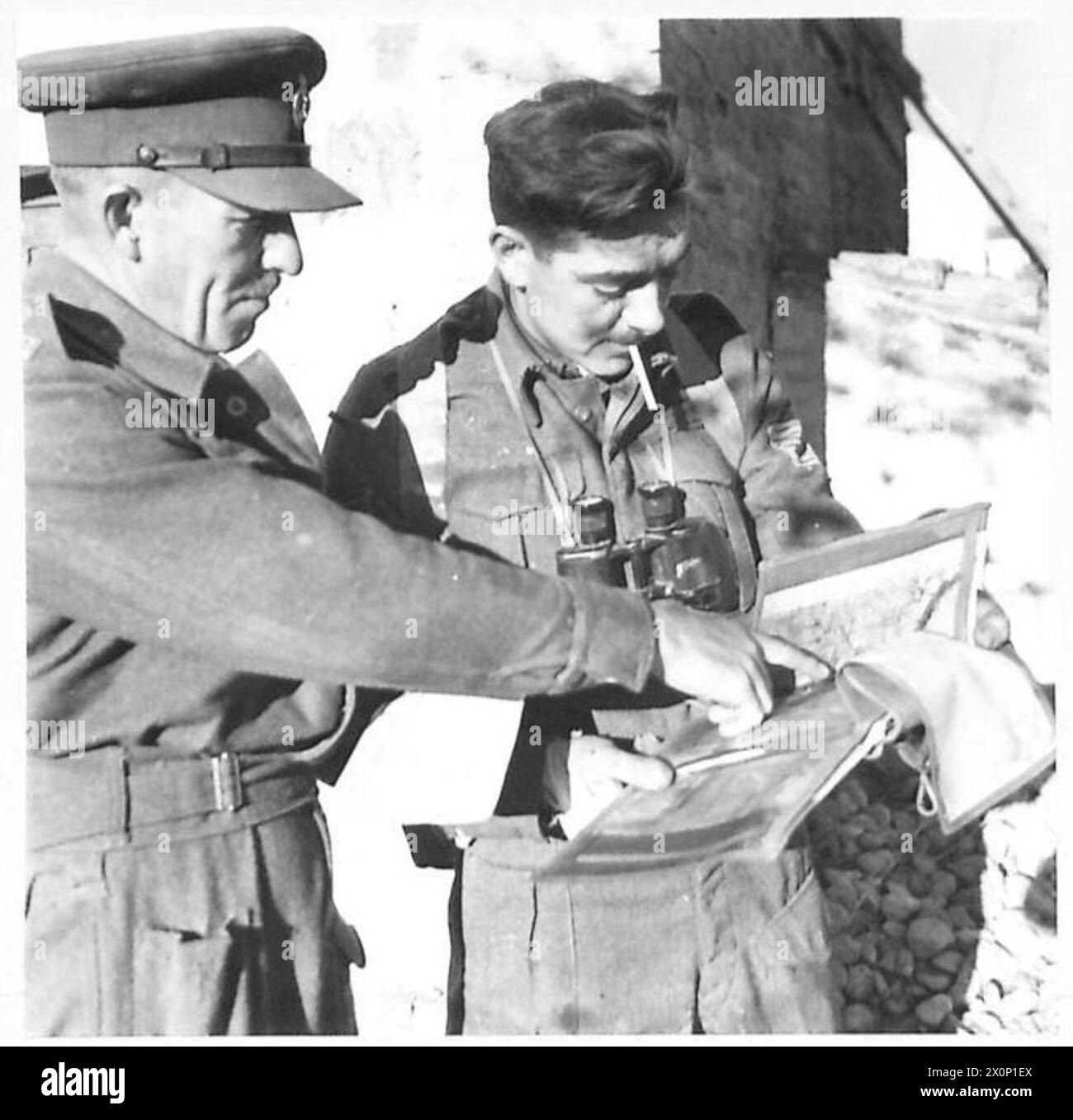 Captain Tramer provides map references and tank positions to Sergeant S ...