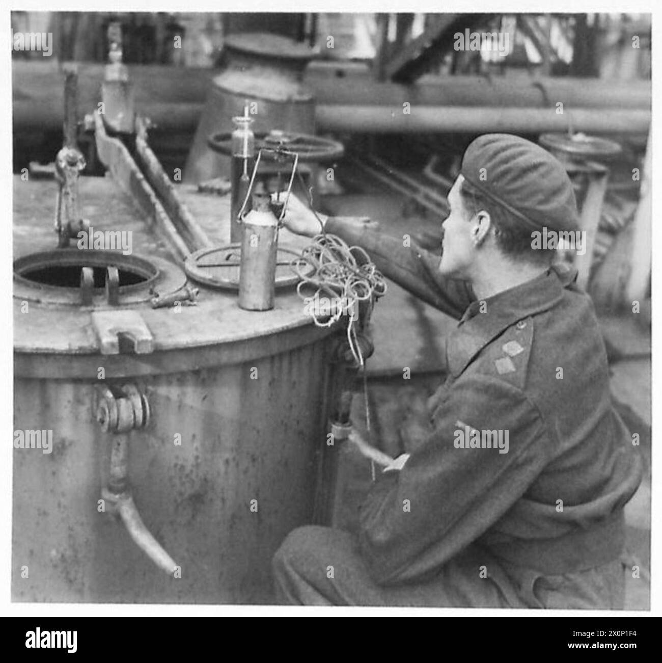 Personnel examine petroleum samples on board a tanker ship ...