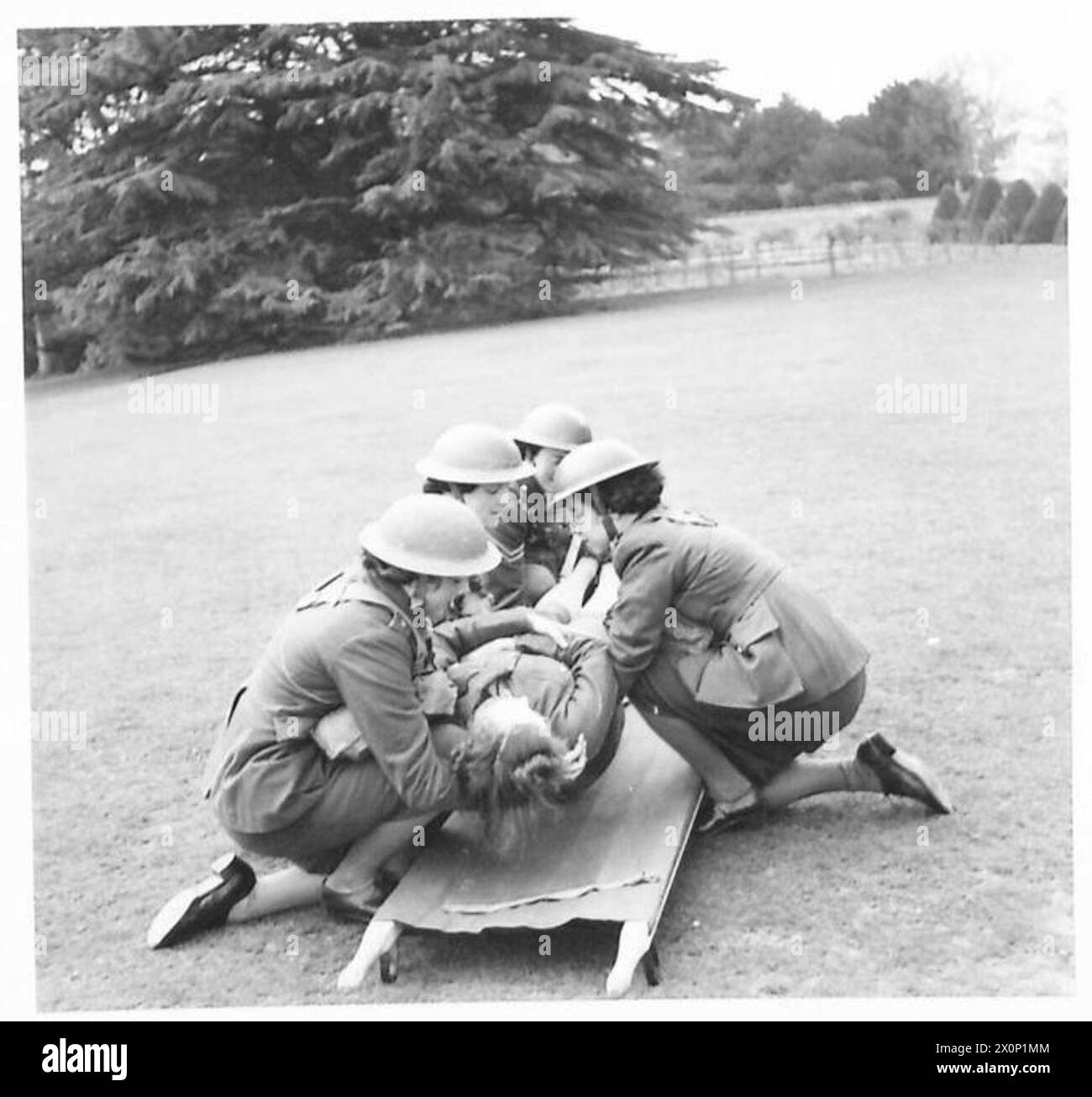 A.T.S. IN TRAINING - First Aid practice, a "casualty" being lifted on ...