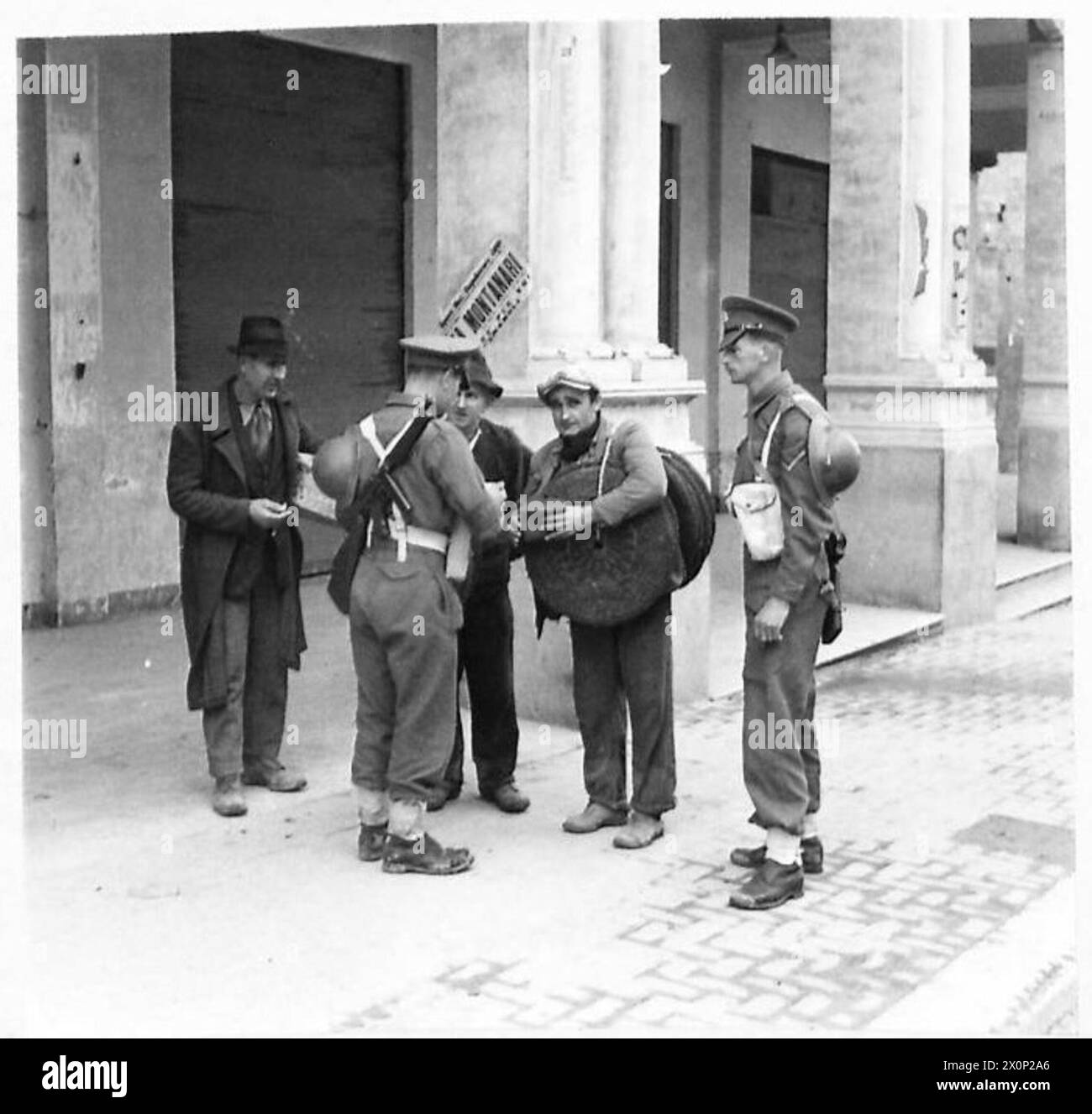 Lance Corporals D. Turner and H. Wentzell inspect Italian civilians ...