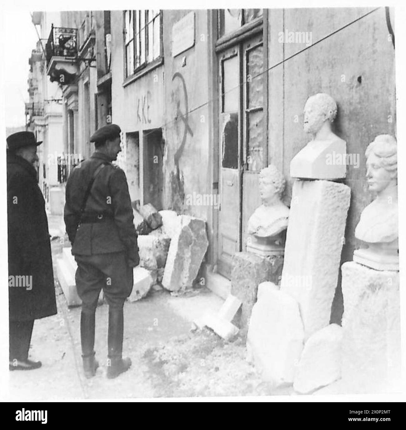 Field Marshal Alexander and Lord Moran observe a stone-mason's window ...