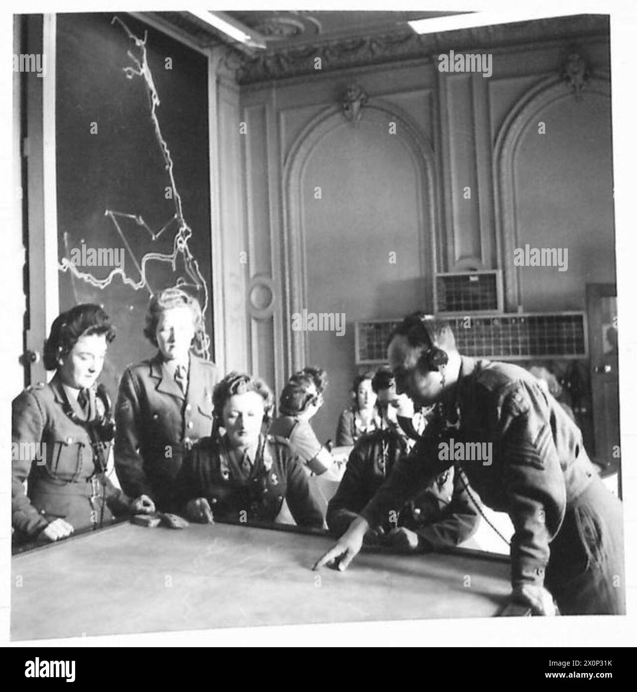 A.T.S. plotters and switchboard personnel at No.405 Gun Operations Room ...
