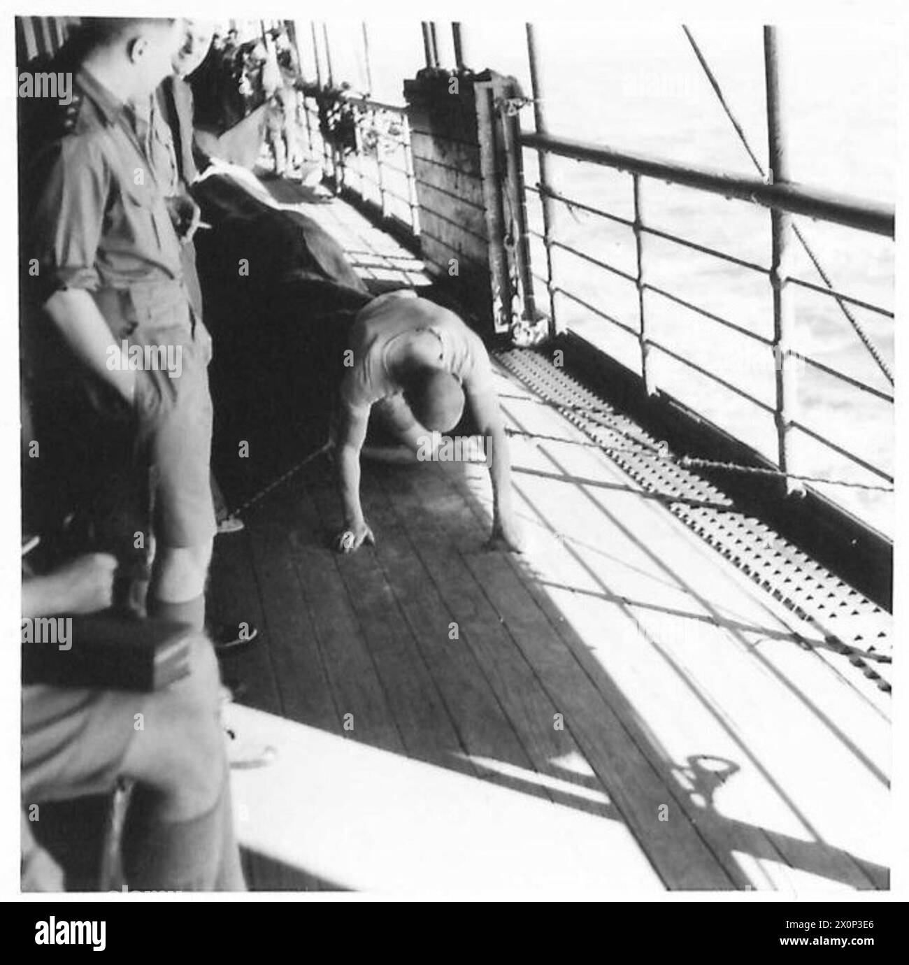 Troop ship passengers participate in an obstacle race during a convoy ...