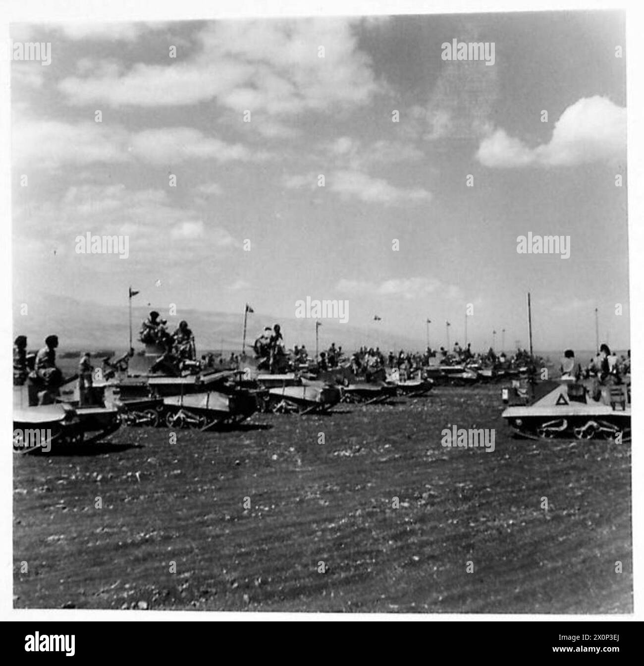 Light tanks and Bren carriers pass in line at the saluting base in ...
