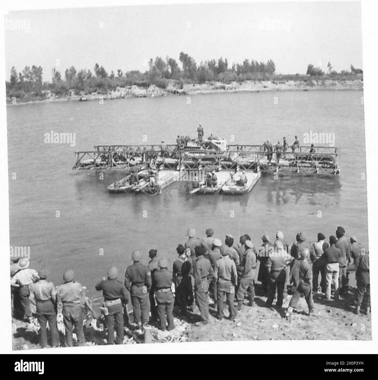 A section of Bailey bridge is floated to the north bank of the River Po ...