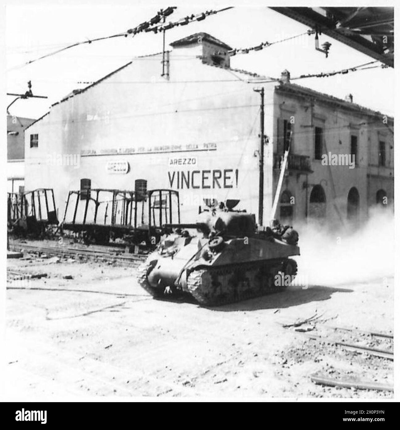 A Sherman tank of the British Eighth Army passes the 'Arezzo' sign on a ...