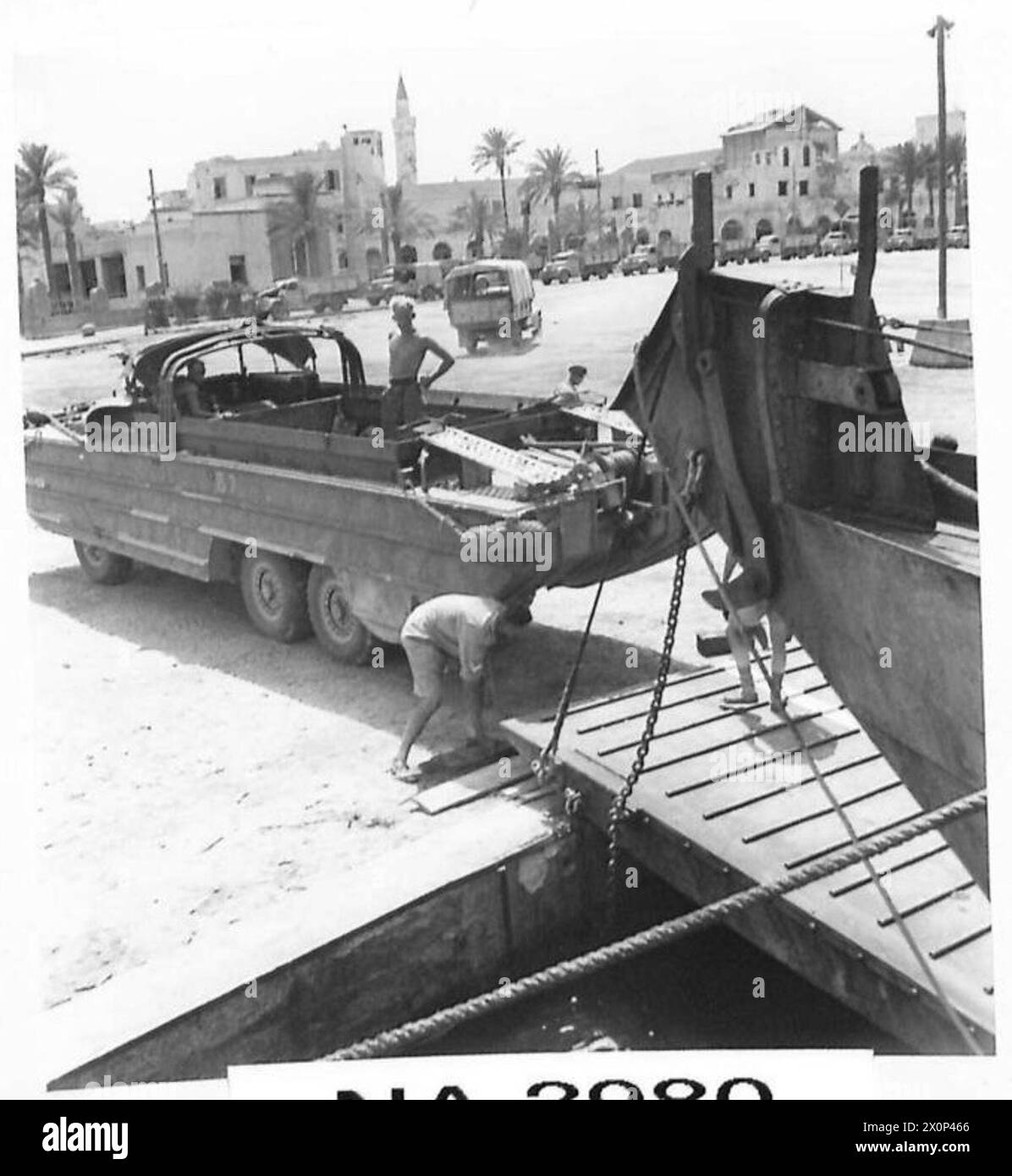 INVASION PREPARATIONS AT TRIPOLI - An amphibious 3-tonner being loaded ...