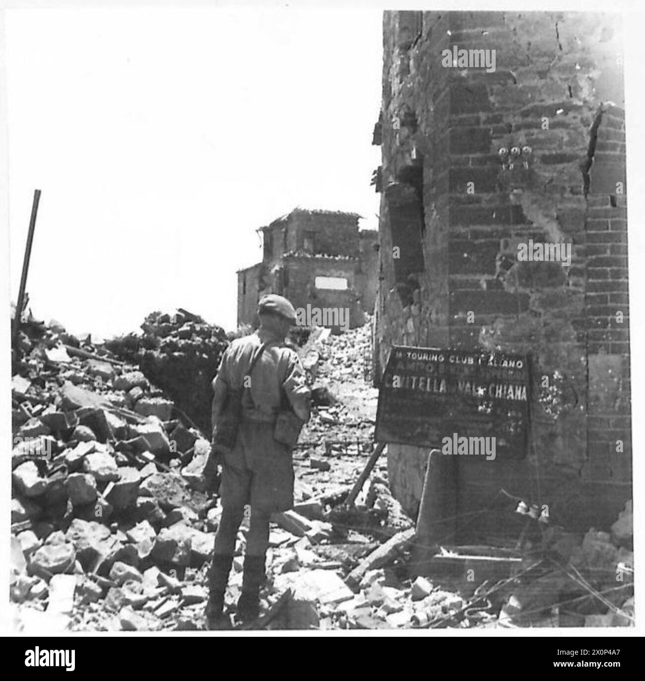 A British soldier walks through the damaged streets of Civitella, with ...