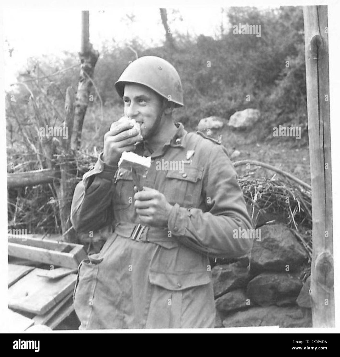 Infantrymen, including Nespoli Alessaniro, take a brief meal break on ...
