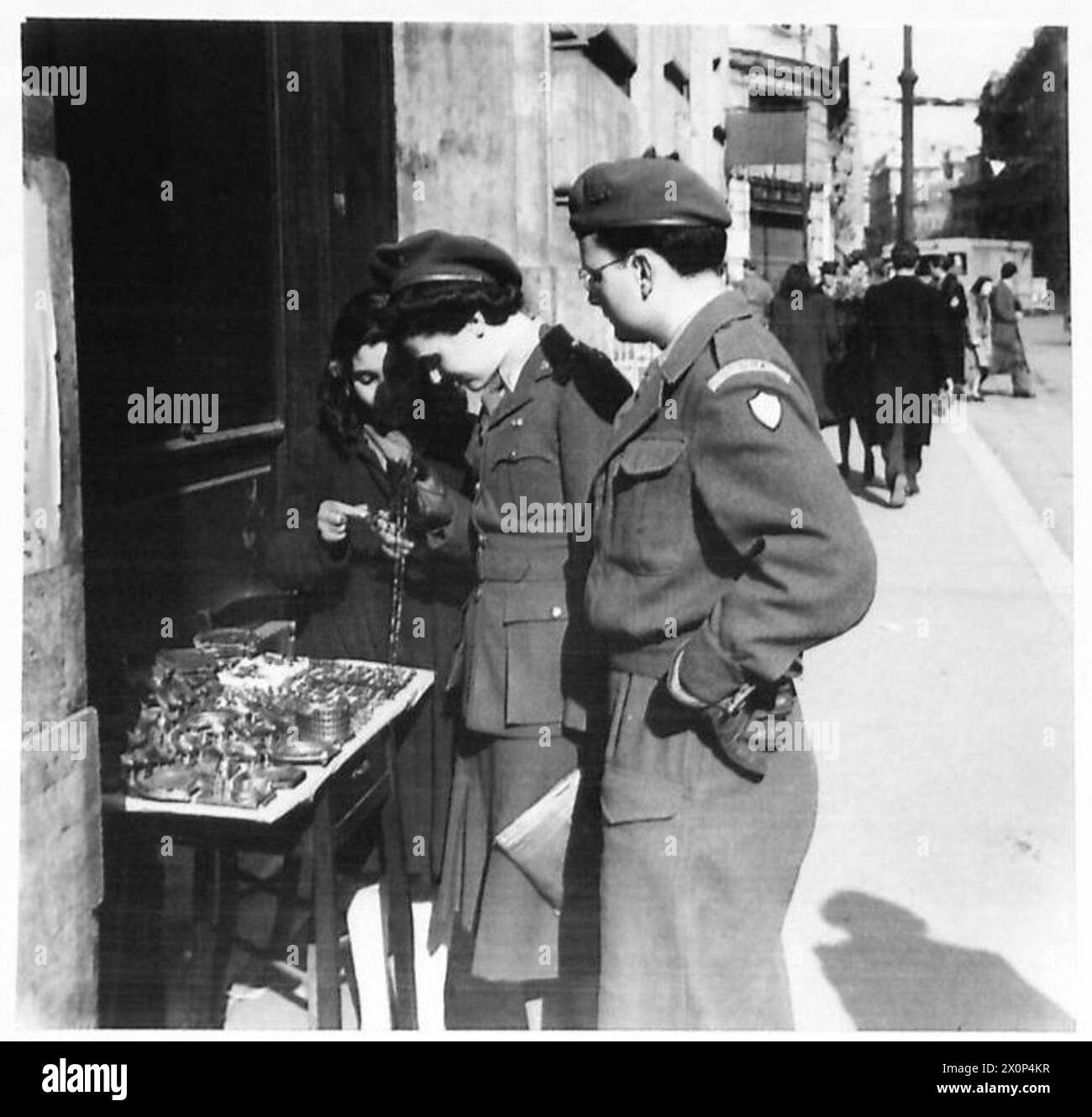 AMERICAN FIELD SERVICE WITH THE EIGHTH ARMY - They buy souvenirs from a ...