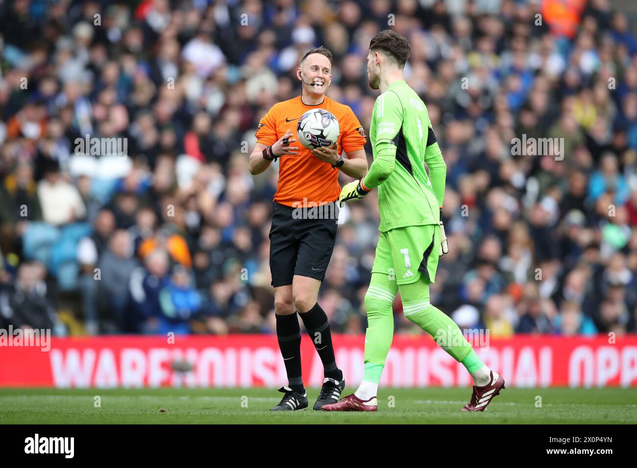 Referee James Bell (left) speaks to Leeds United goalkeeper Illan ...