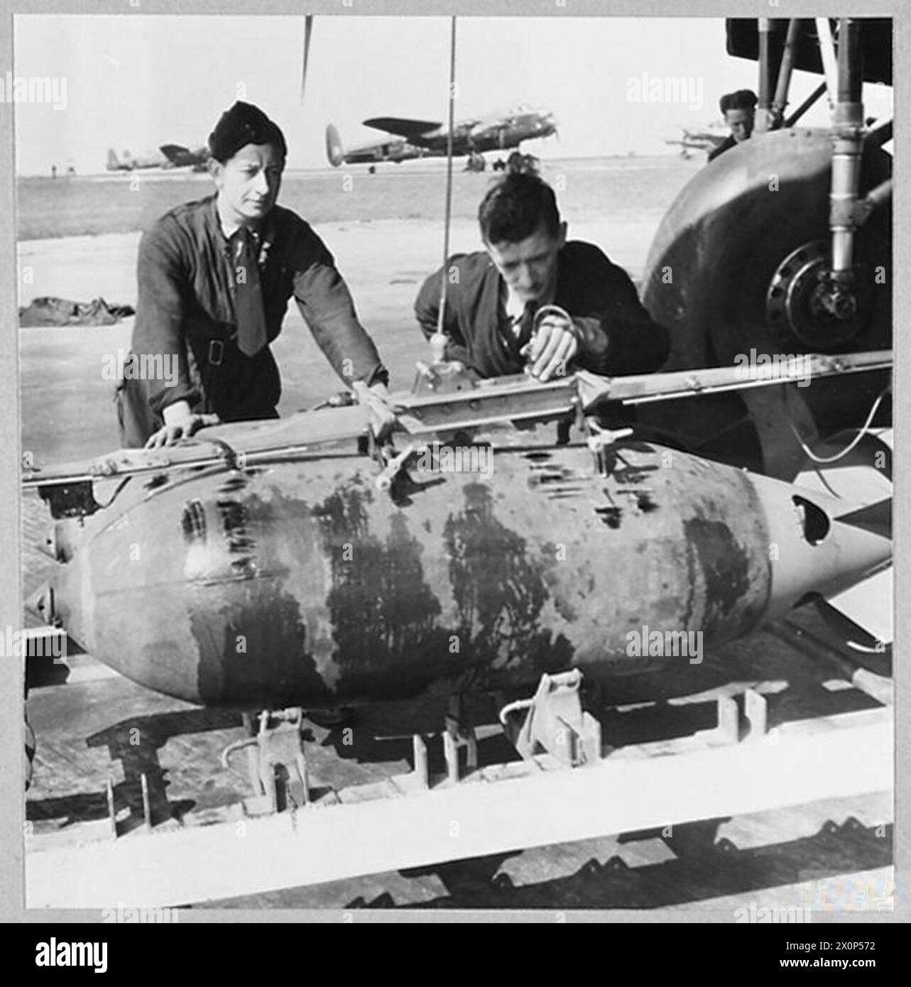 A Lancaster bomber returns from a mission; bombs are hoisted into ...