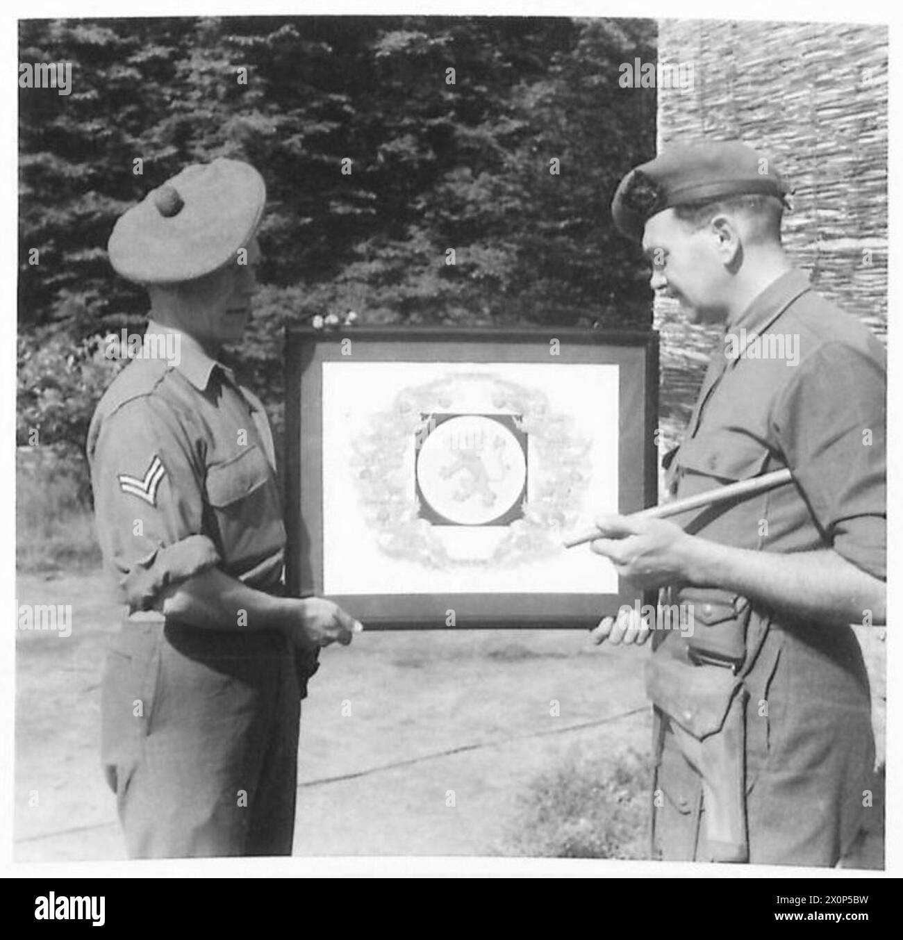 Corporal L. Clatworthy of Swansea holds an ornamental scroll depicting ...