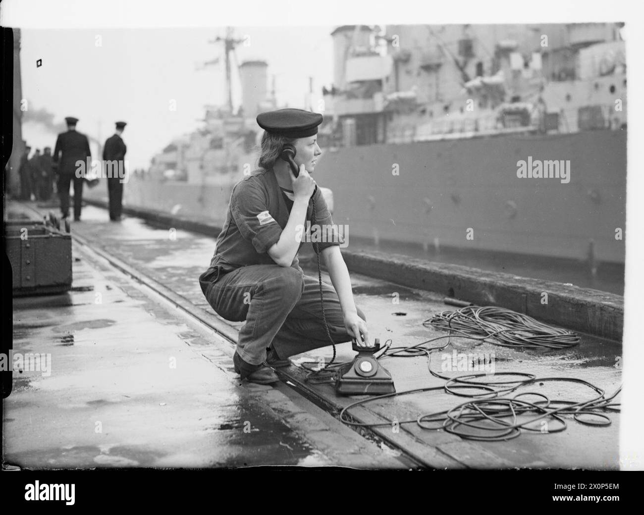 A Wren of the Women's Royal Naval Service tests a ship's telephone ...