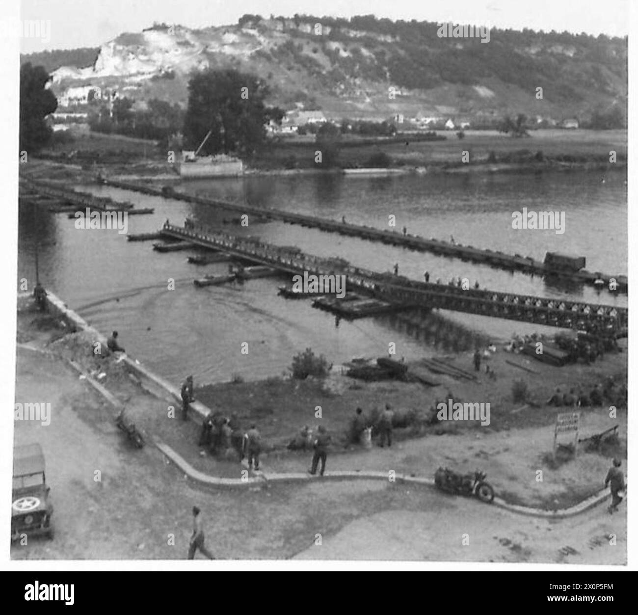 The nearly completed Bailey bridge and the pontoon bridge are used by ...