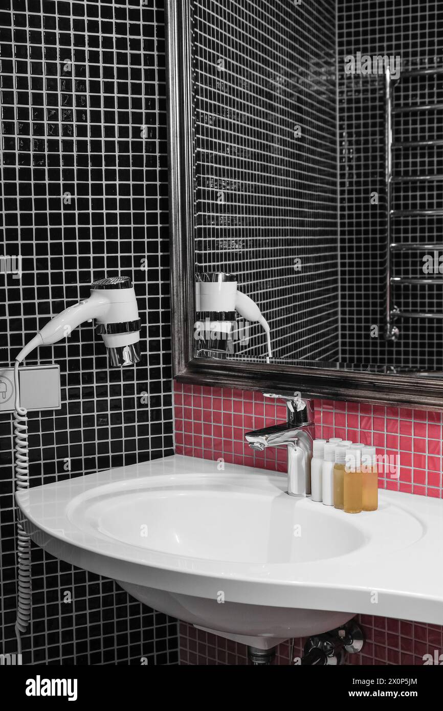 Bathroom interior with white sink, mirror and cosmetics for personal ...