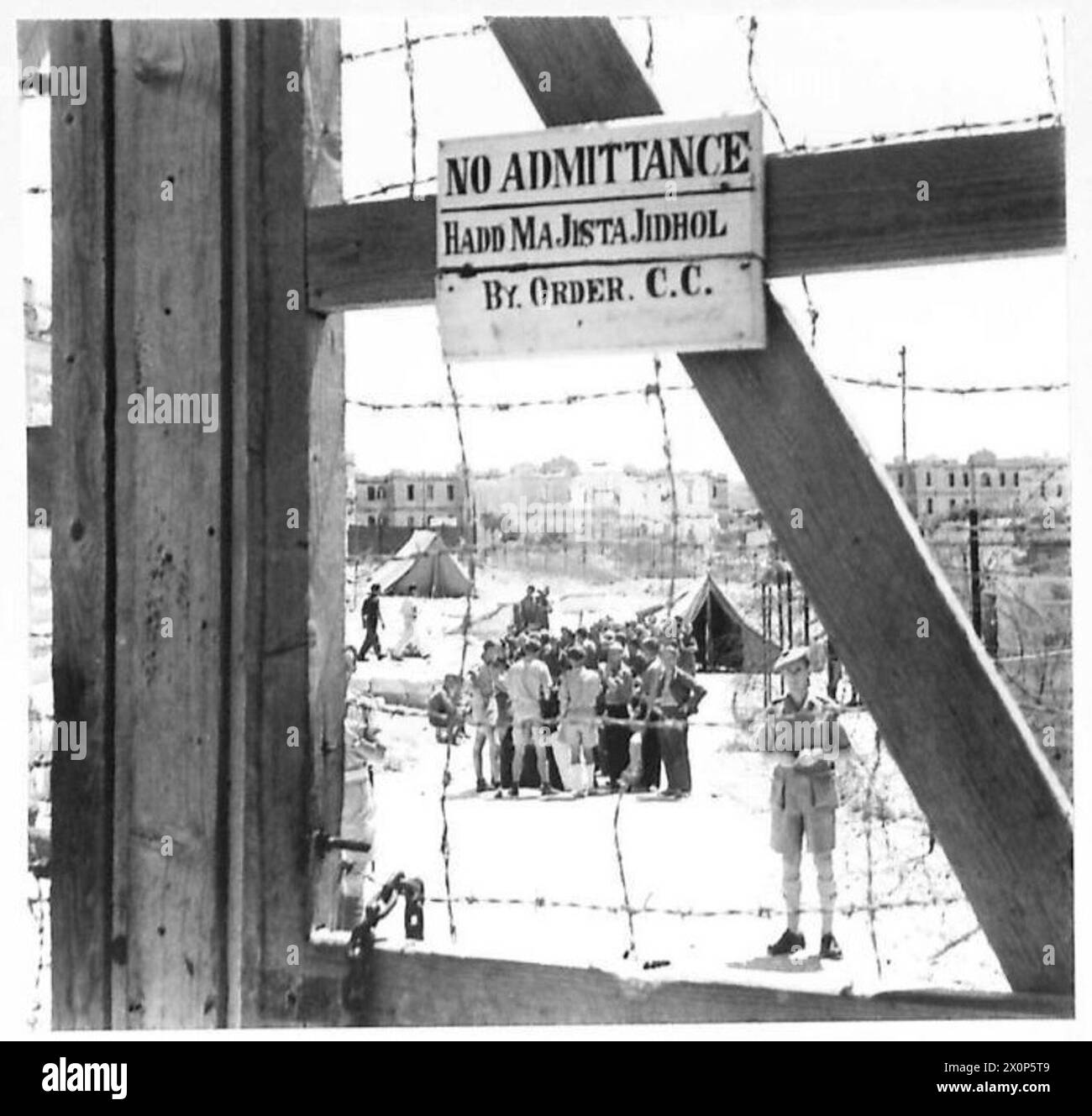 FIRST SICILIAN PRISONERS LEAVE MALTA - Shot through gate of cage with ...