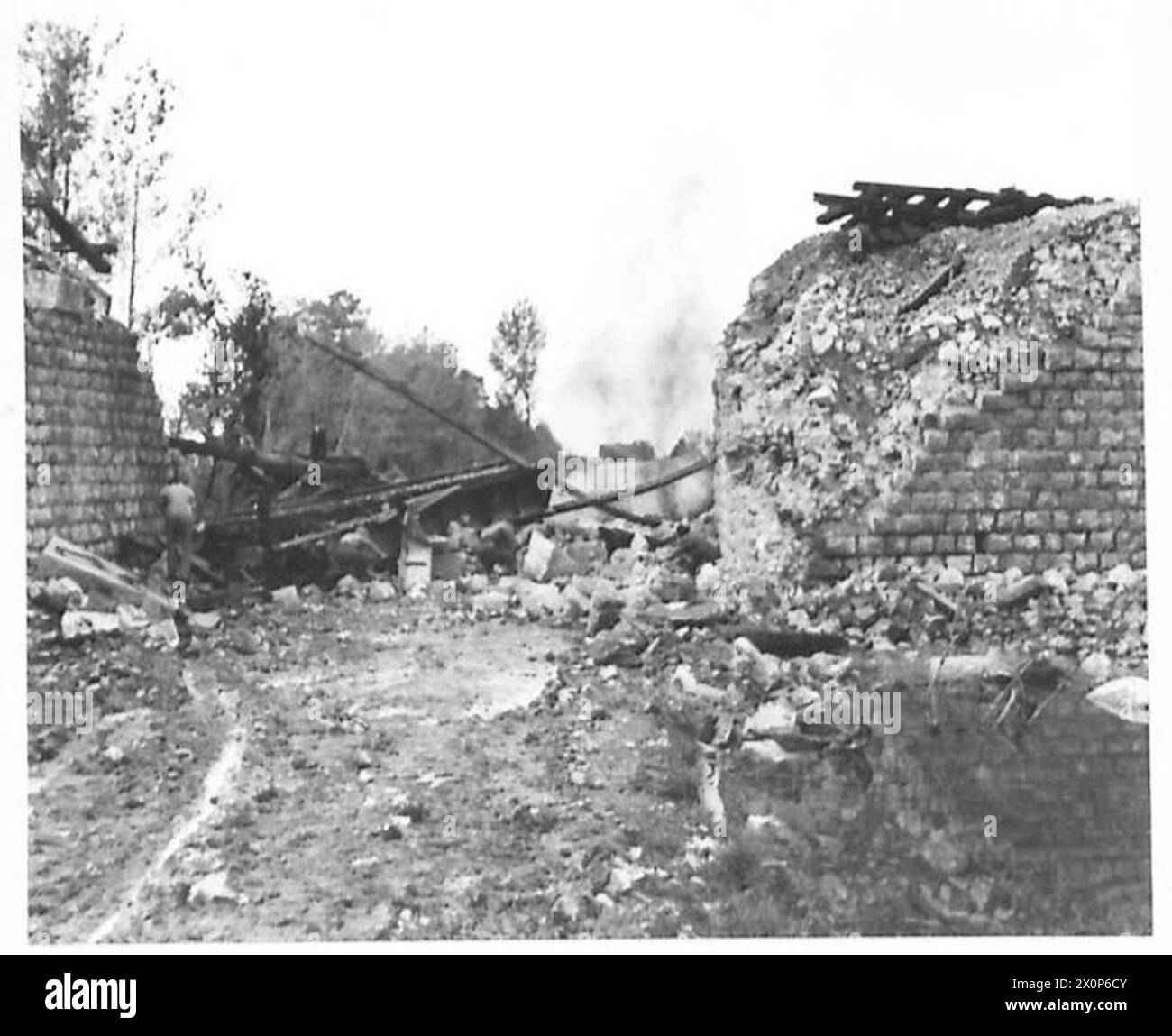 Fifth Army personnel in Italy clear a road obstruction while taking ...