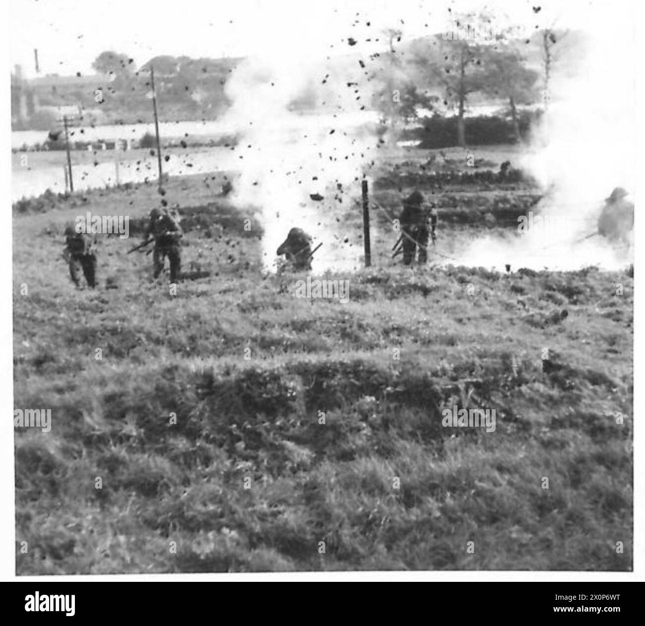 Troops undergo realistic training, navigating a barbed wire obstacle ...