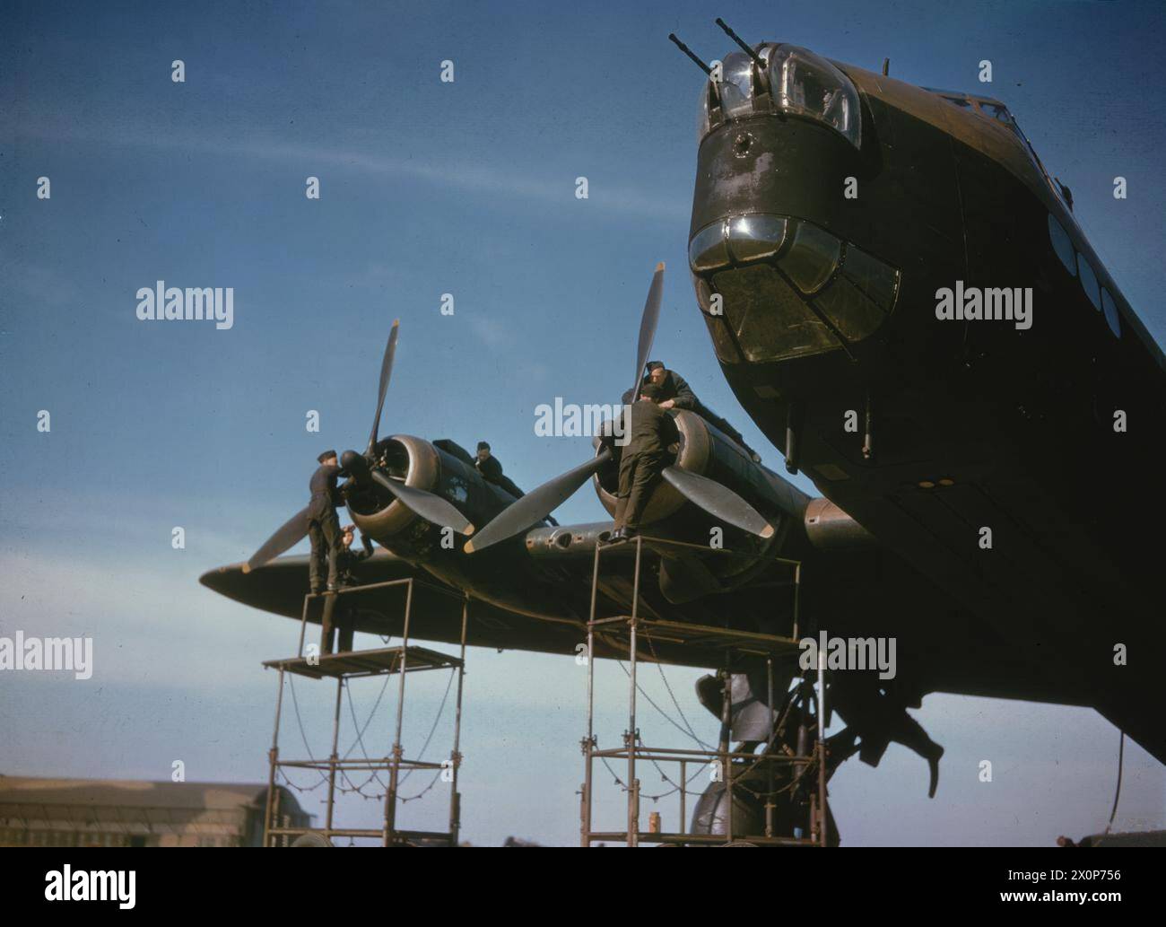 ROYAL AIR FORCE BOMBER COMMAND, 1942-1945. - Mechanics standing on gantries, service the ...