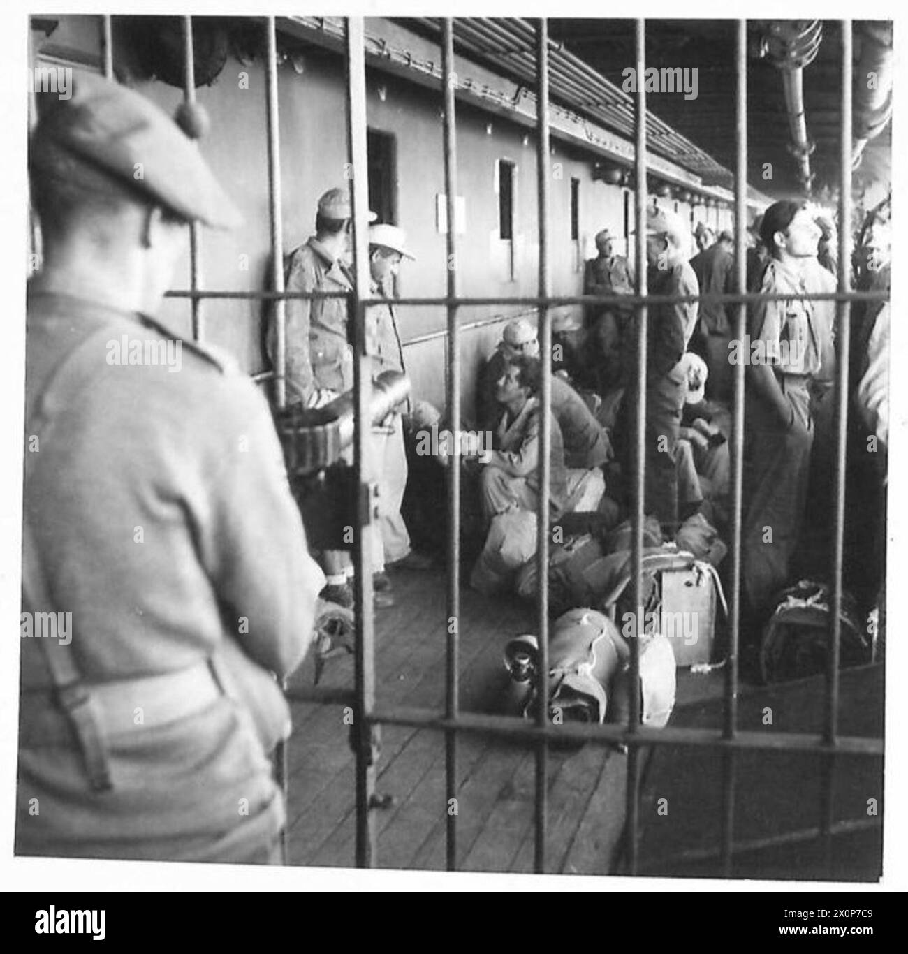 A British Lewis gunner supervises German prisoners during transport to ...