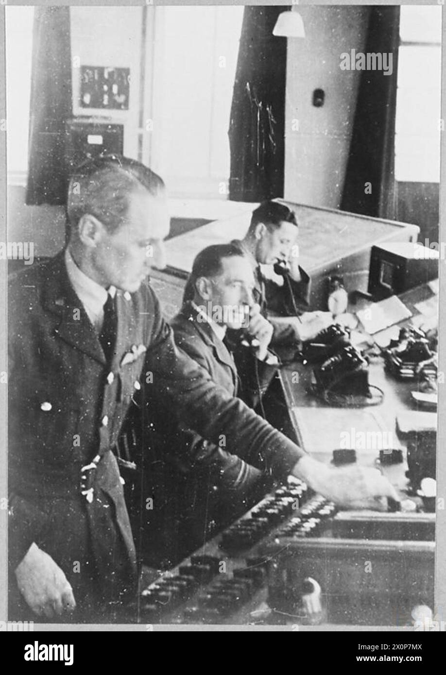 Scenes inside an RAF station control tower showing staff monitoring ...