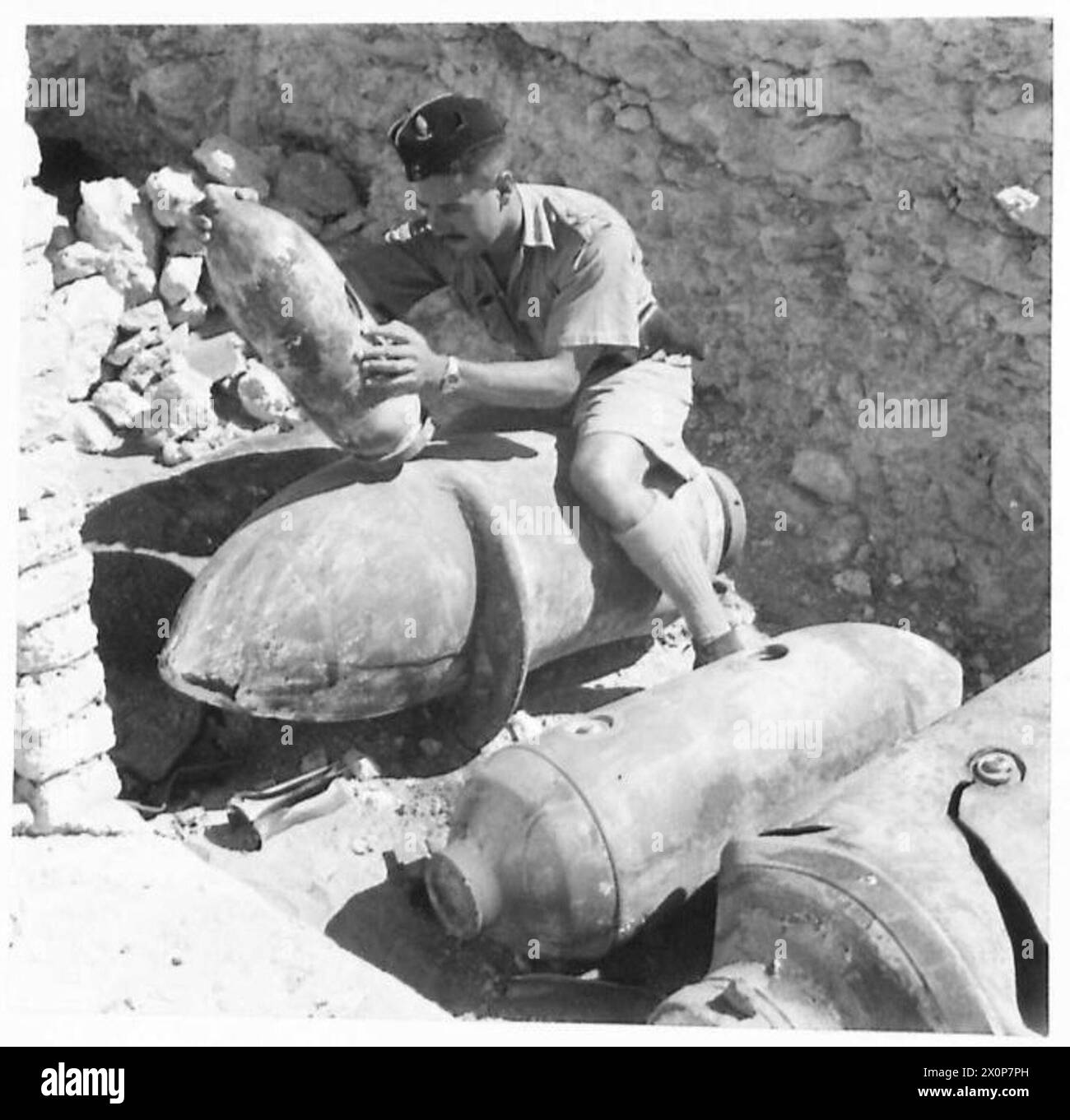 A BOMB DISPOSAL UNIT'S WORK - A British officer examining one of the ...