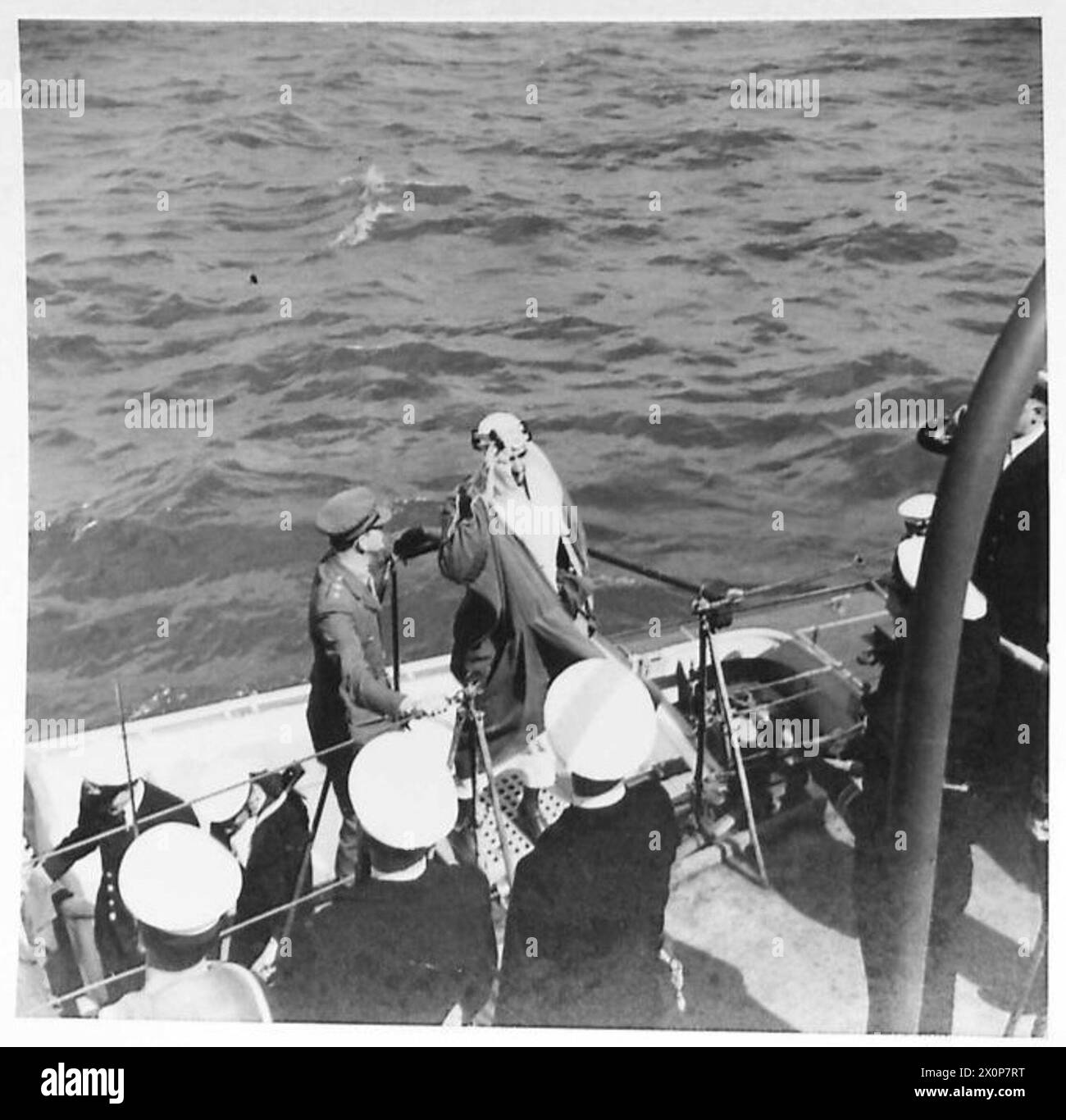 Photograph showing HRH Emir Mansur bin 'Abd al-'Aziz boarding the ...