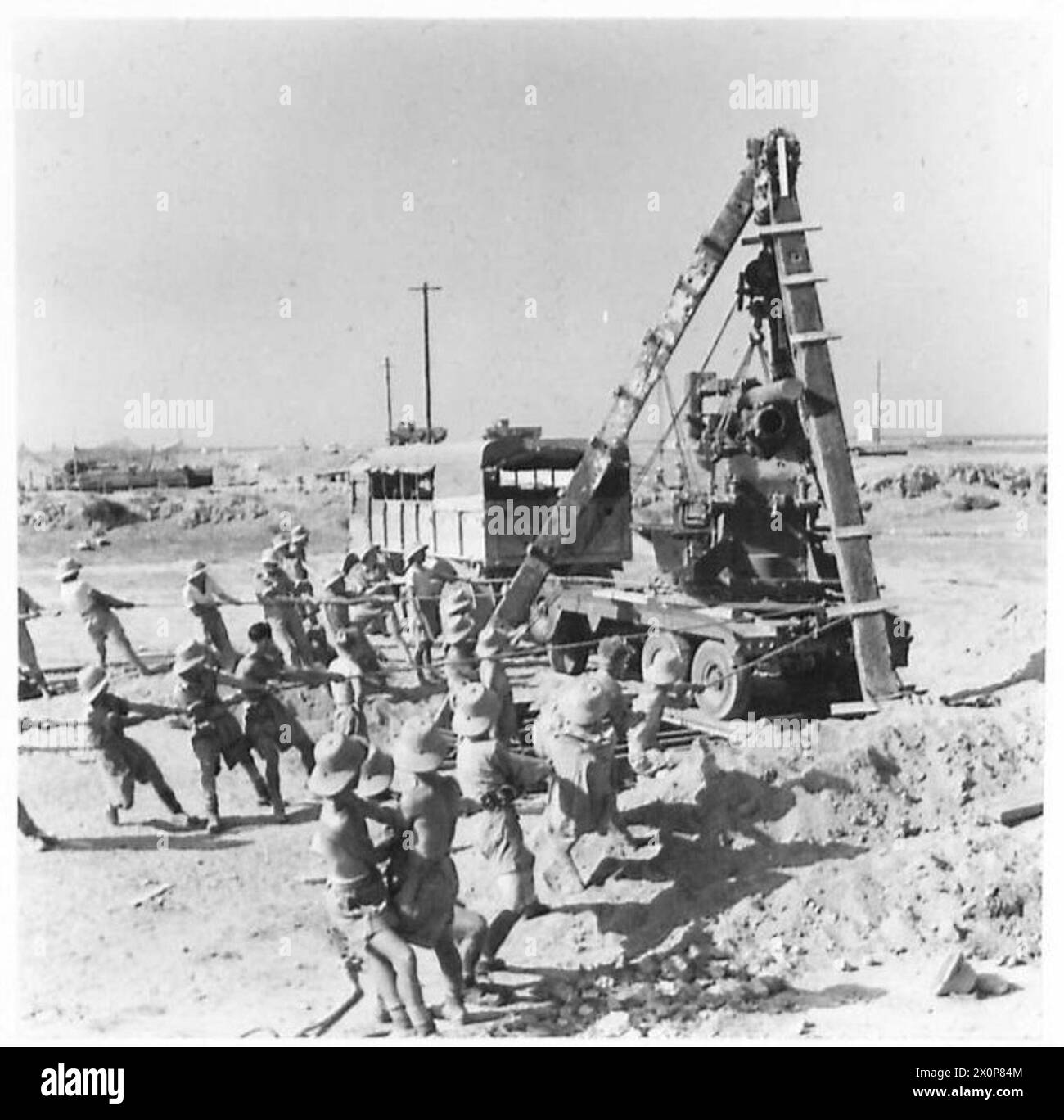 WITH THE GUNNERS IN CYPRUS - The gun being lowered into position ...