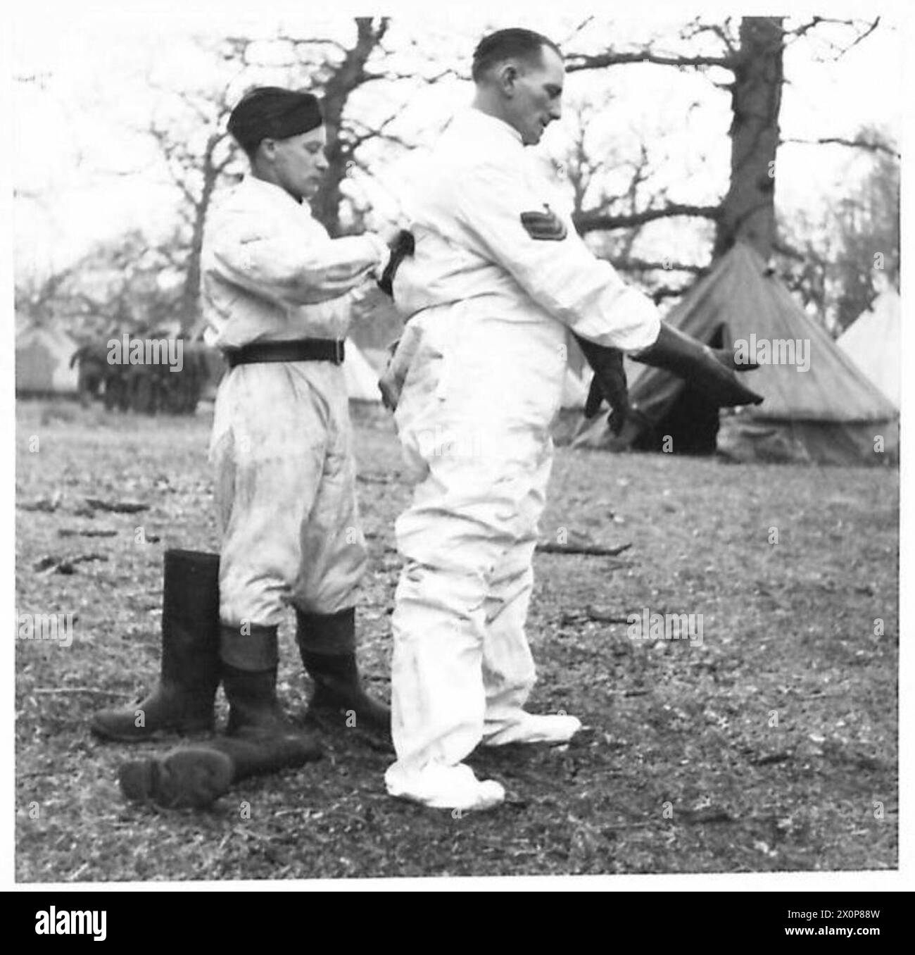 FIELD HYGIENE - Putting on disinfesters uniform. Photographic negative ...