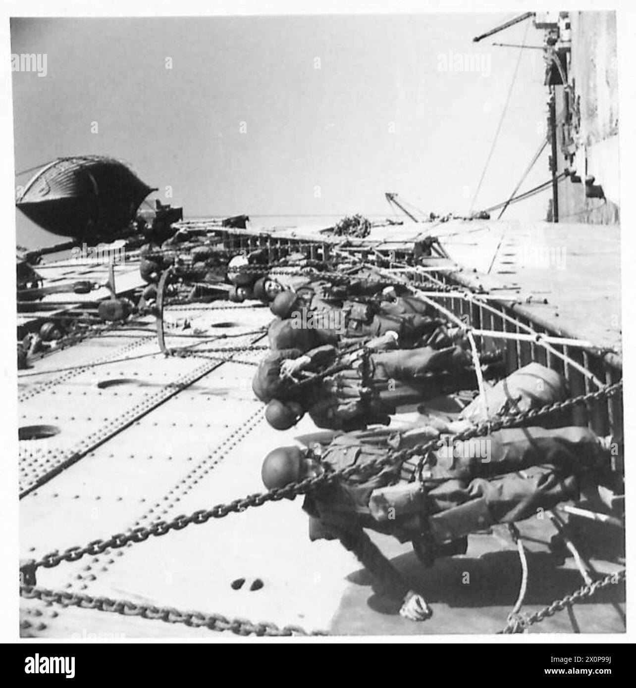 Photograph of British paratroops disembarking from a troopship onto a ...