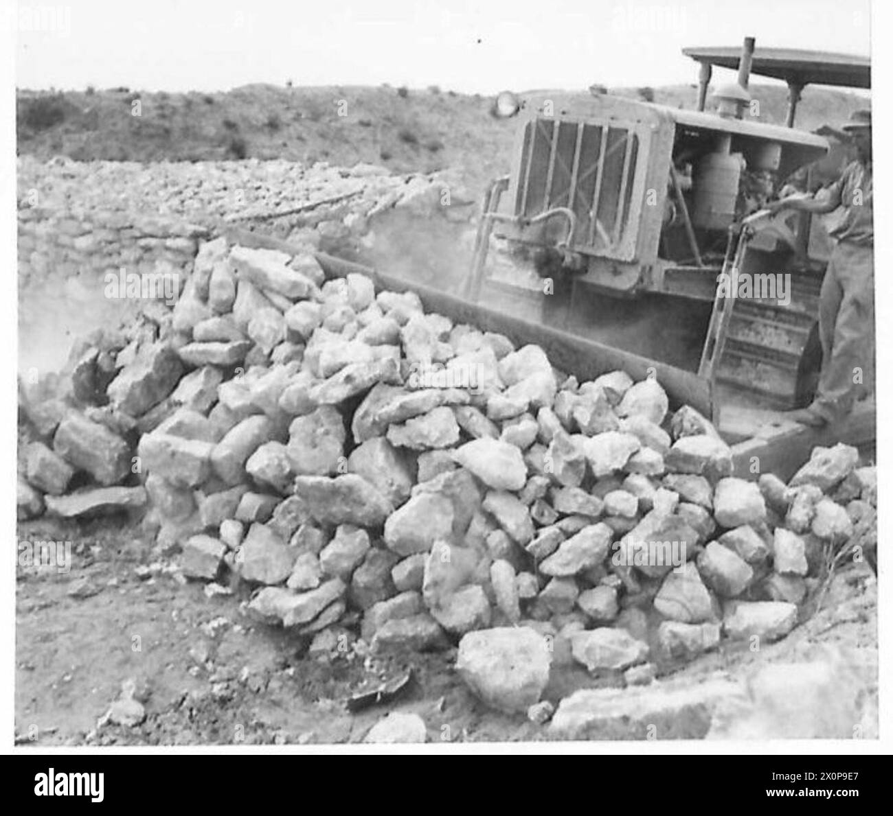 A bulldozer of the Eighth Army completes the demolition of an enemy ...